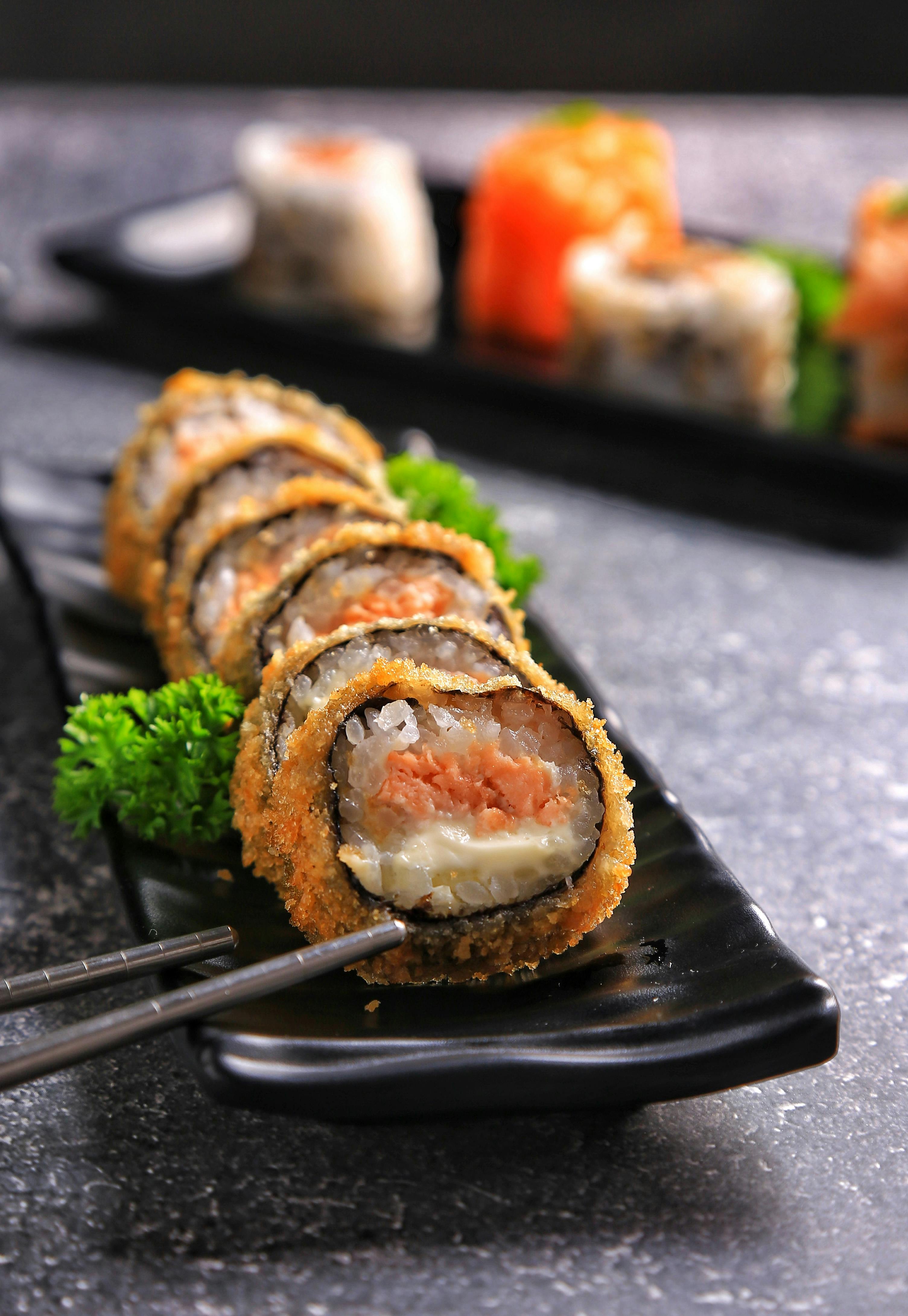 A Chef Using a Blow Torch on Sushi Rolls · Free Stock Photo