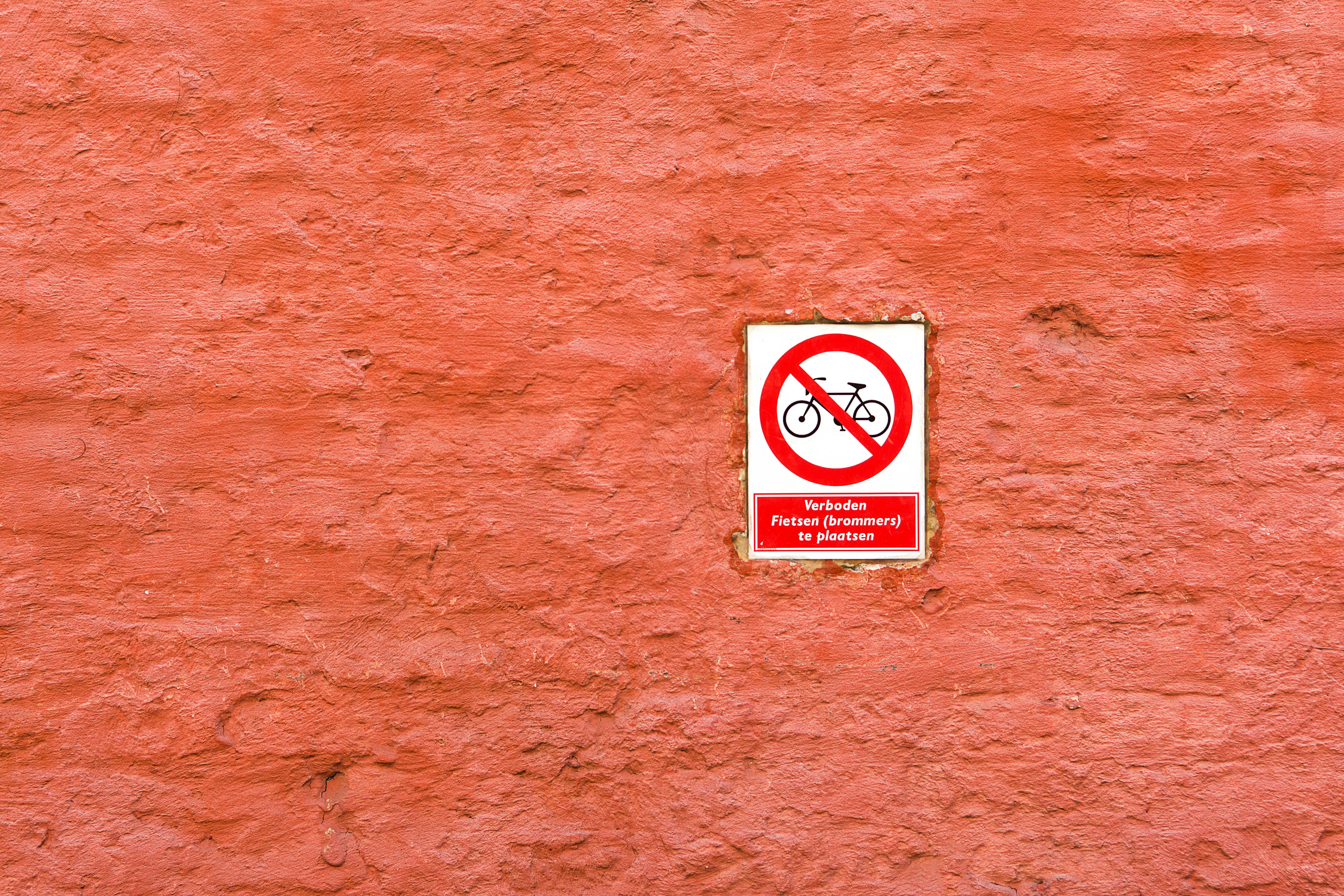 Red and White Road Sign on the Wall · Free Stock Photo