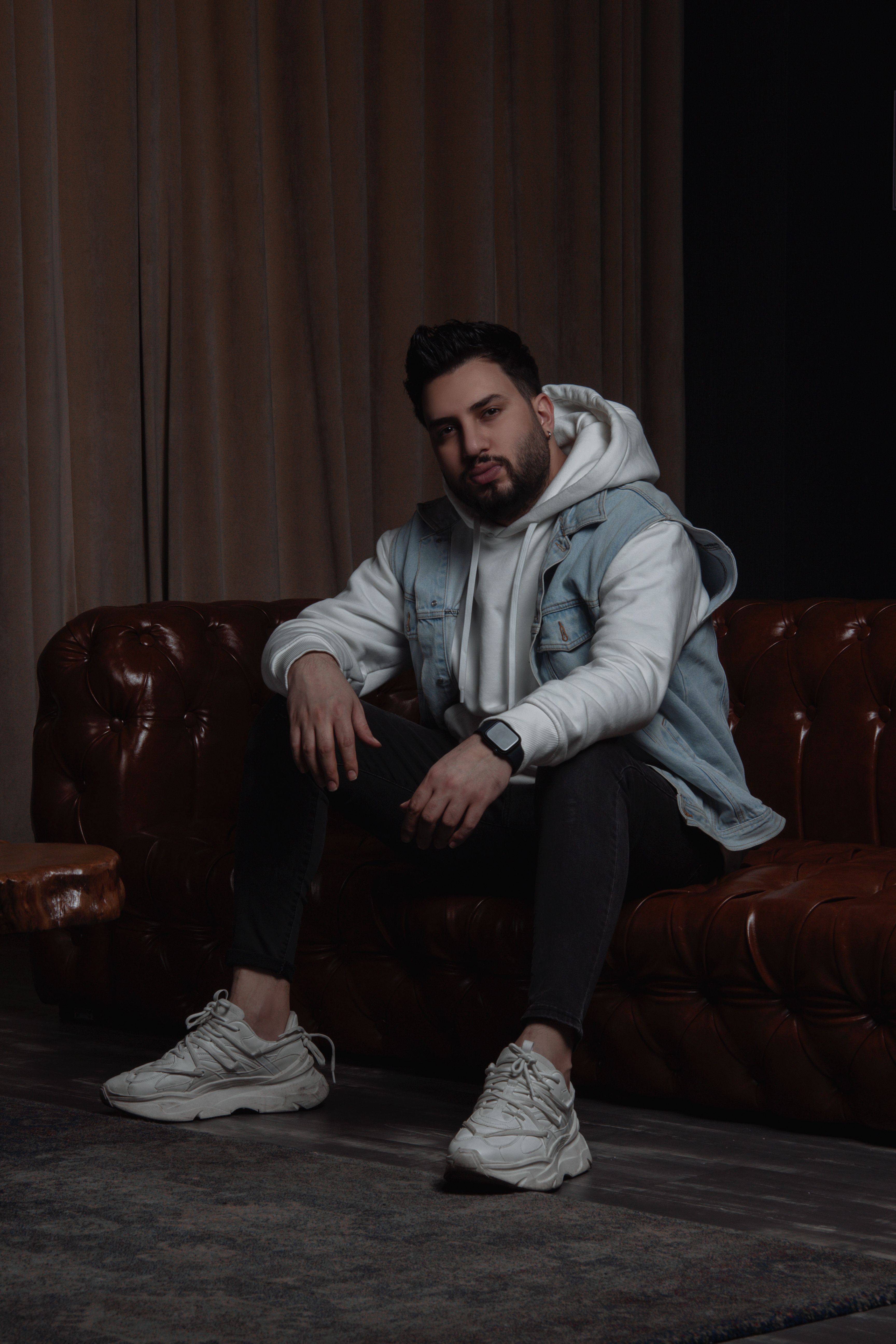Fashionable Man Sitting on a Couch · Free Stock Photo