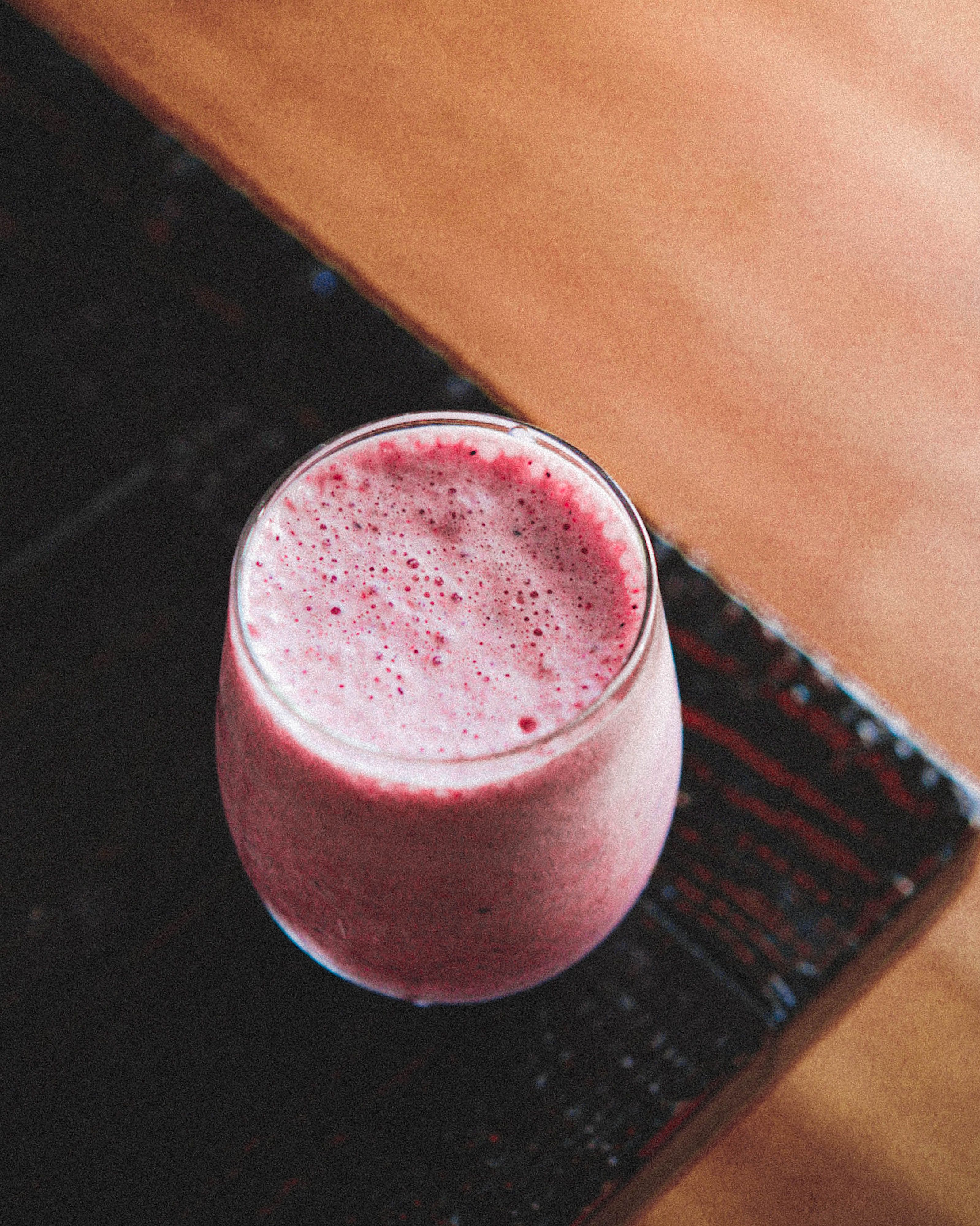 Smoothie Decorated with Strawberry Slices and Flowers · Free Stock Photo