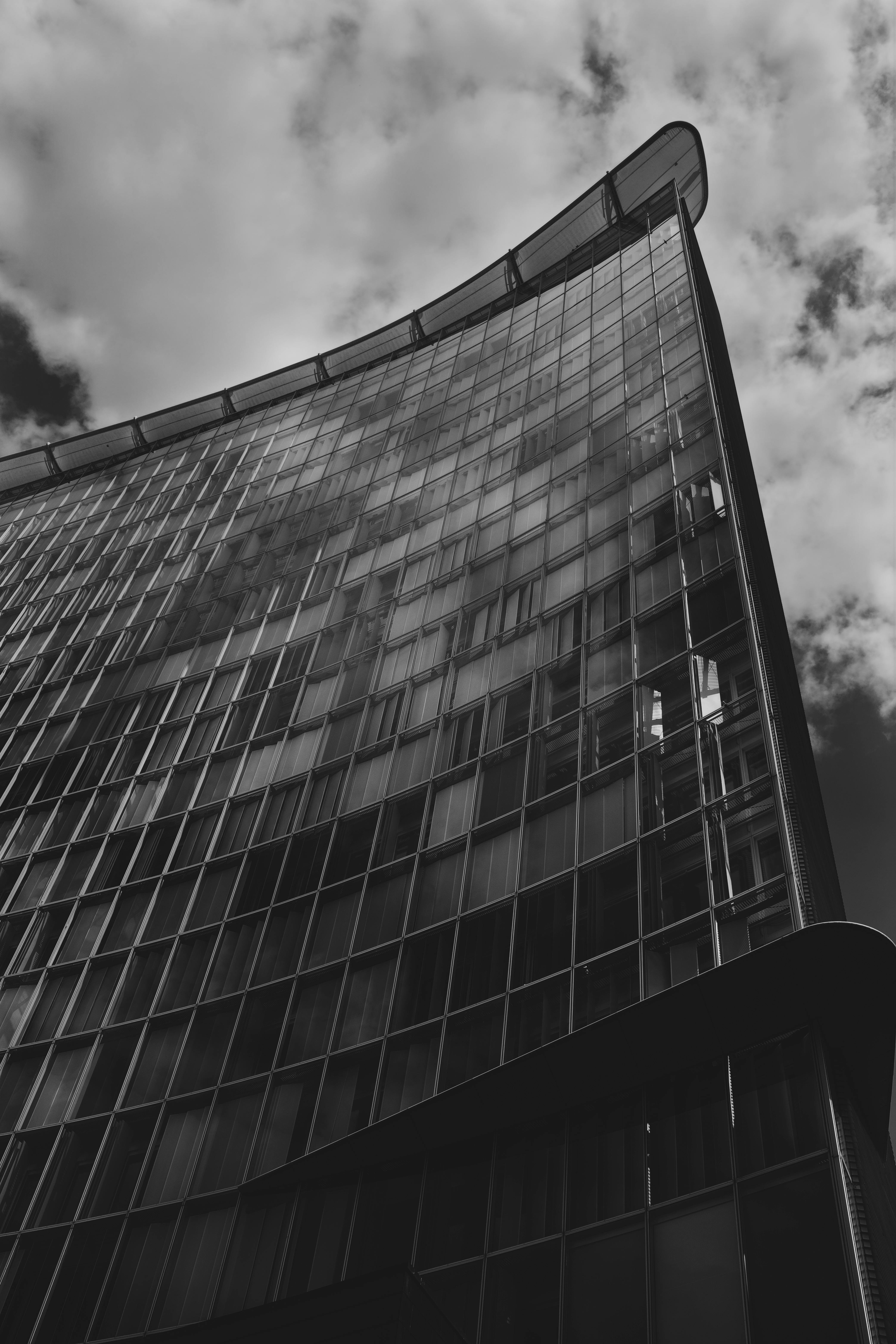 Grayscale Photo of a Glass Building · Free Stock Photo
