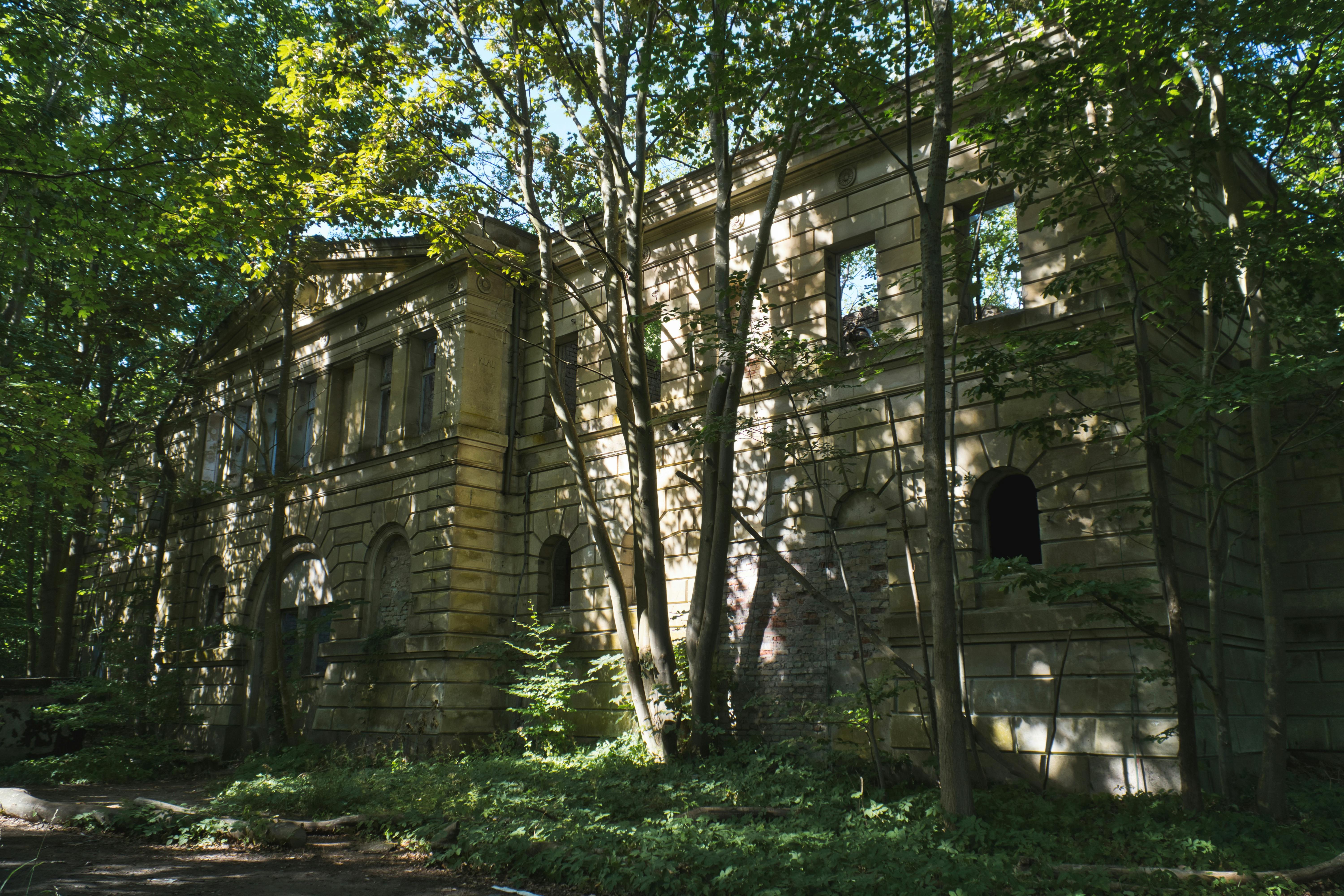 Brown Concrete Building Near Green Trees · Free Stock Photo