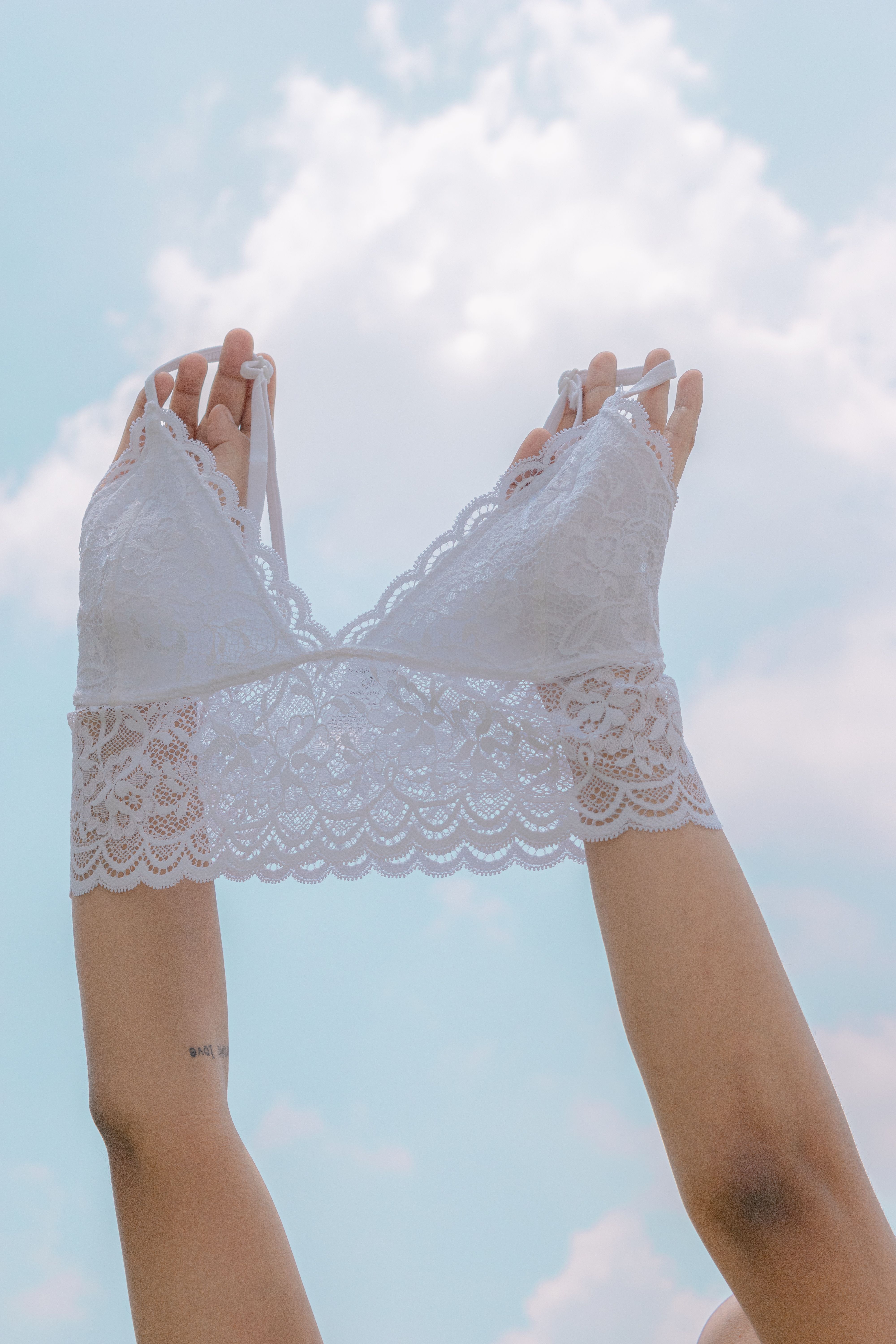 Close Up Photo of a Person Holding White Brassiere · Free Stock Photo