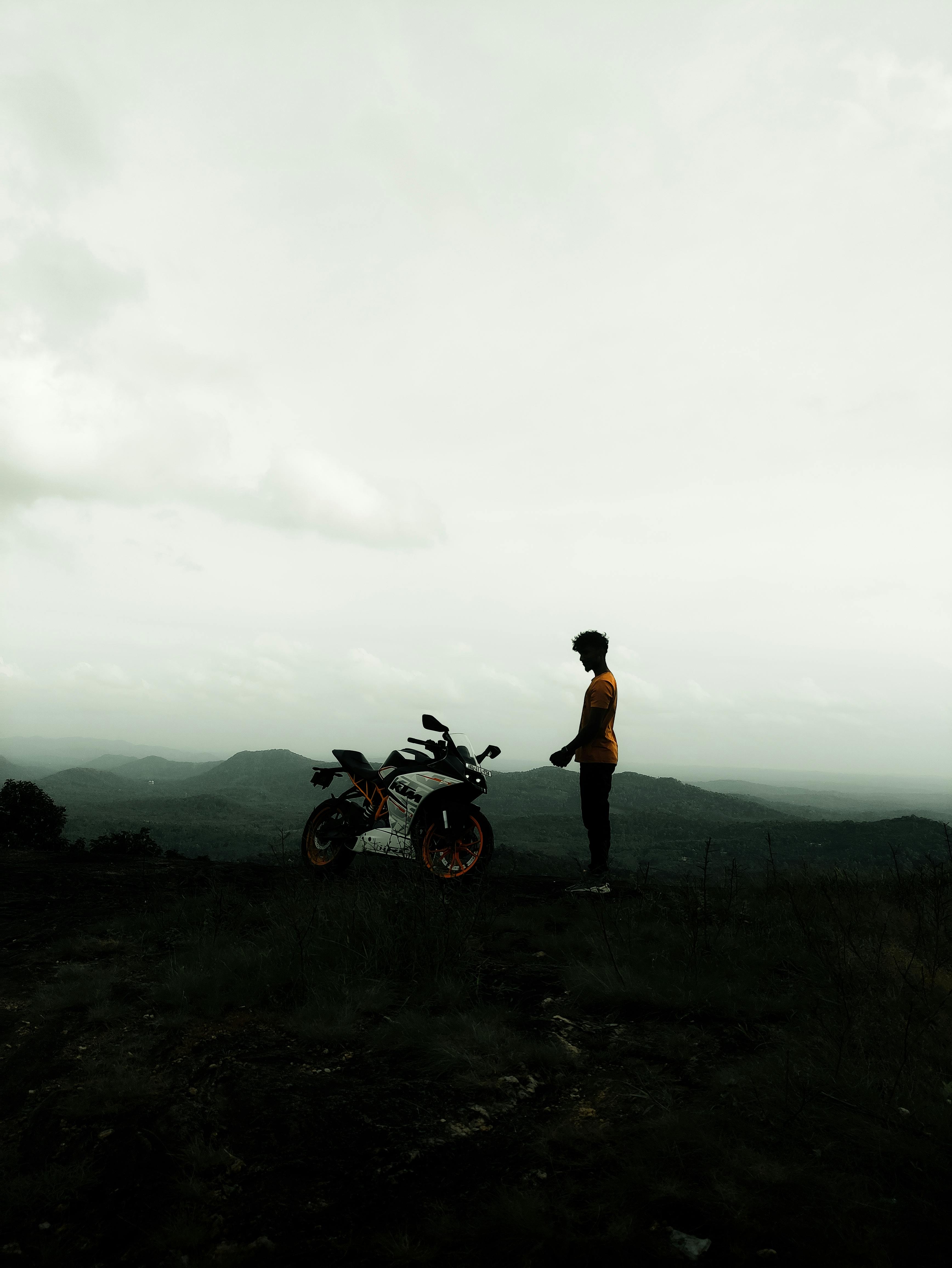A Man Standing Beside the Motorcycle · Free Stock Photo