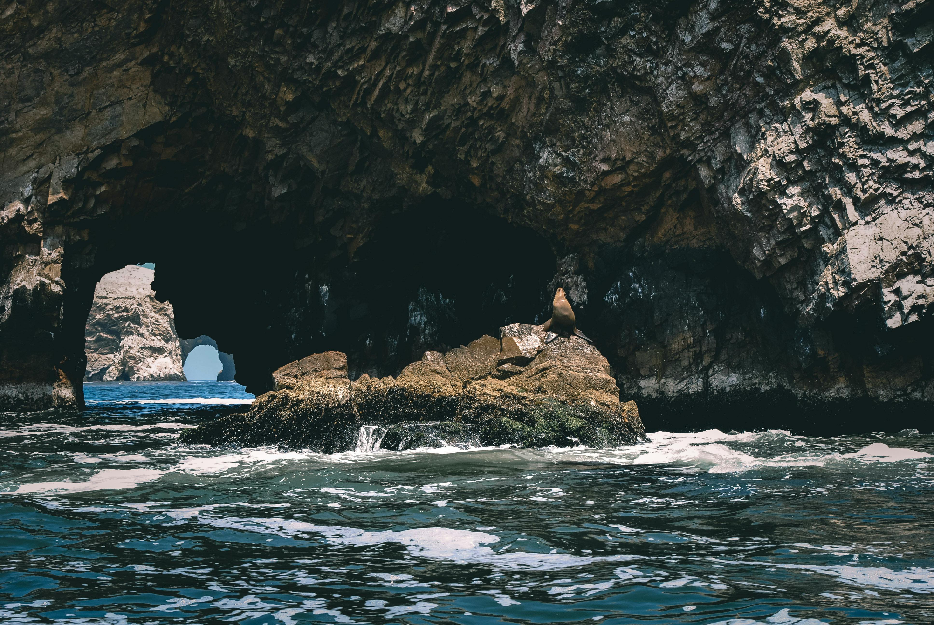 Photographers on a Cave at a Beach · Free Stock Photo