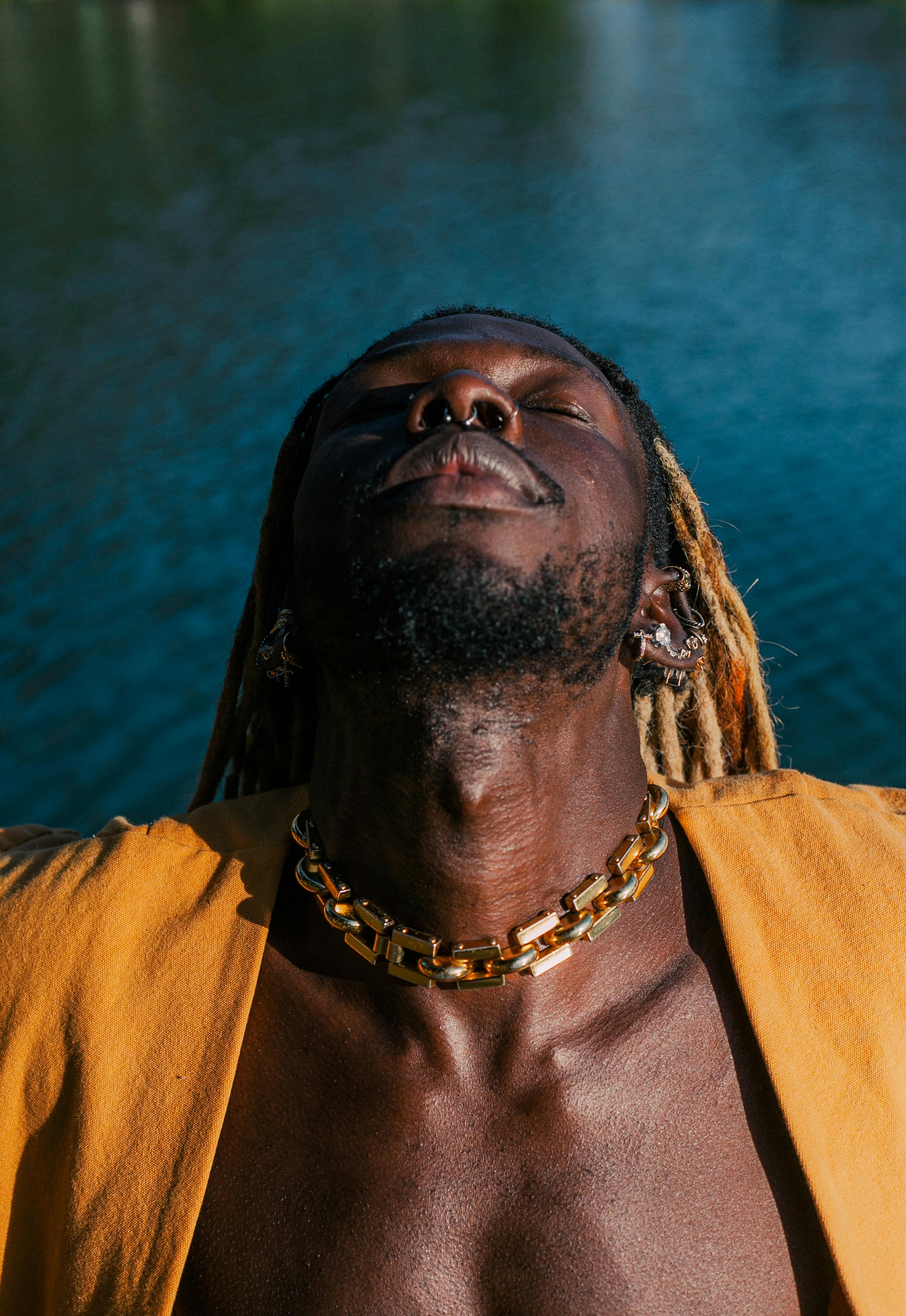 Close Up Photo of a Man Wearing Gold Necklace · Free Stock Photo