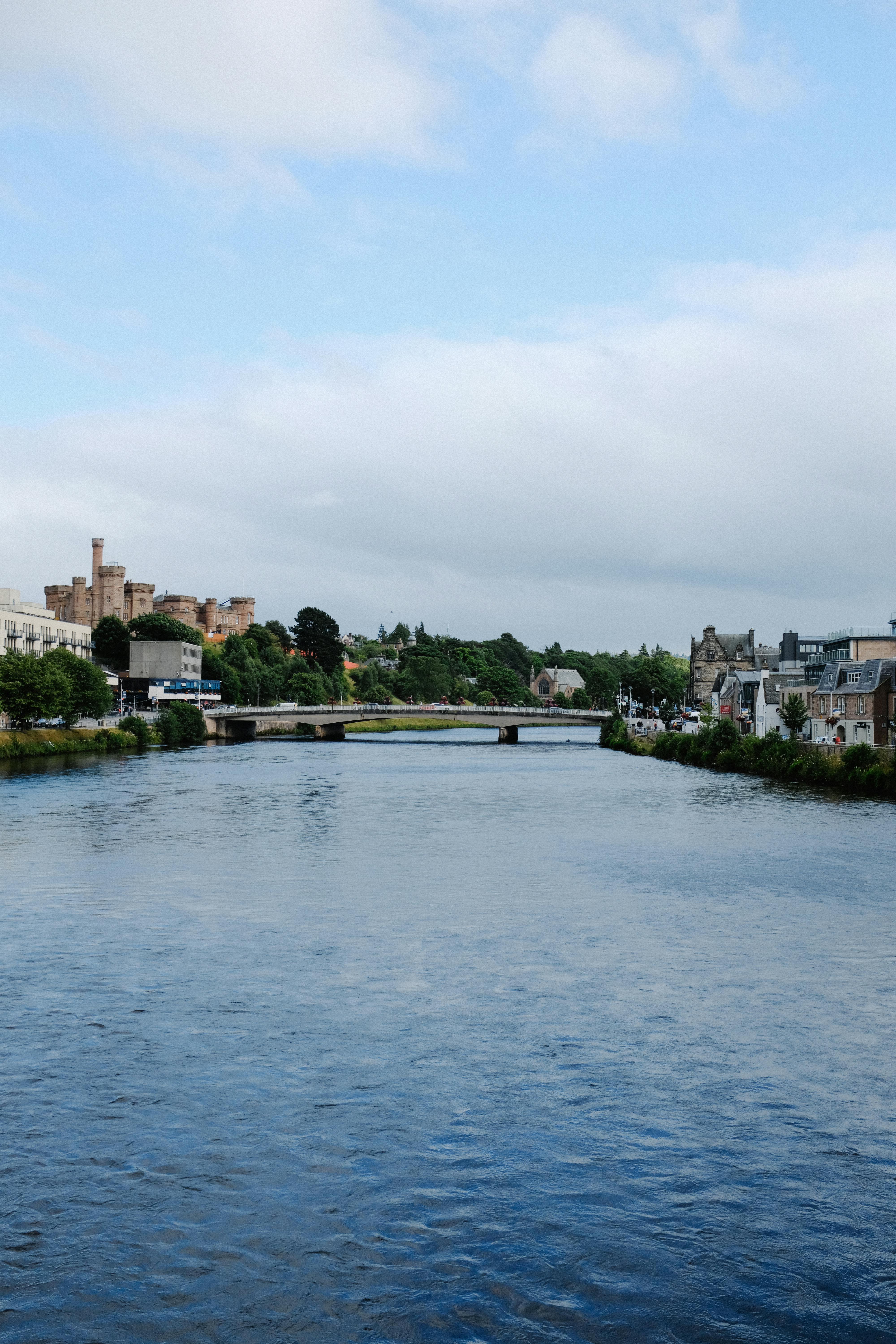 Waterfront Houses and Town Bridge Over a River · Free Stock Photo