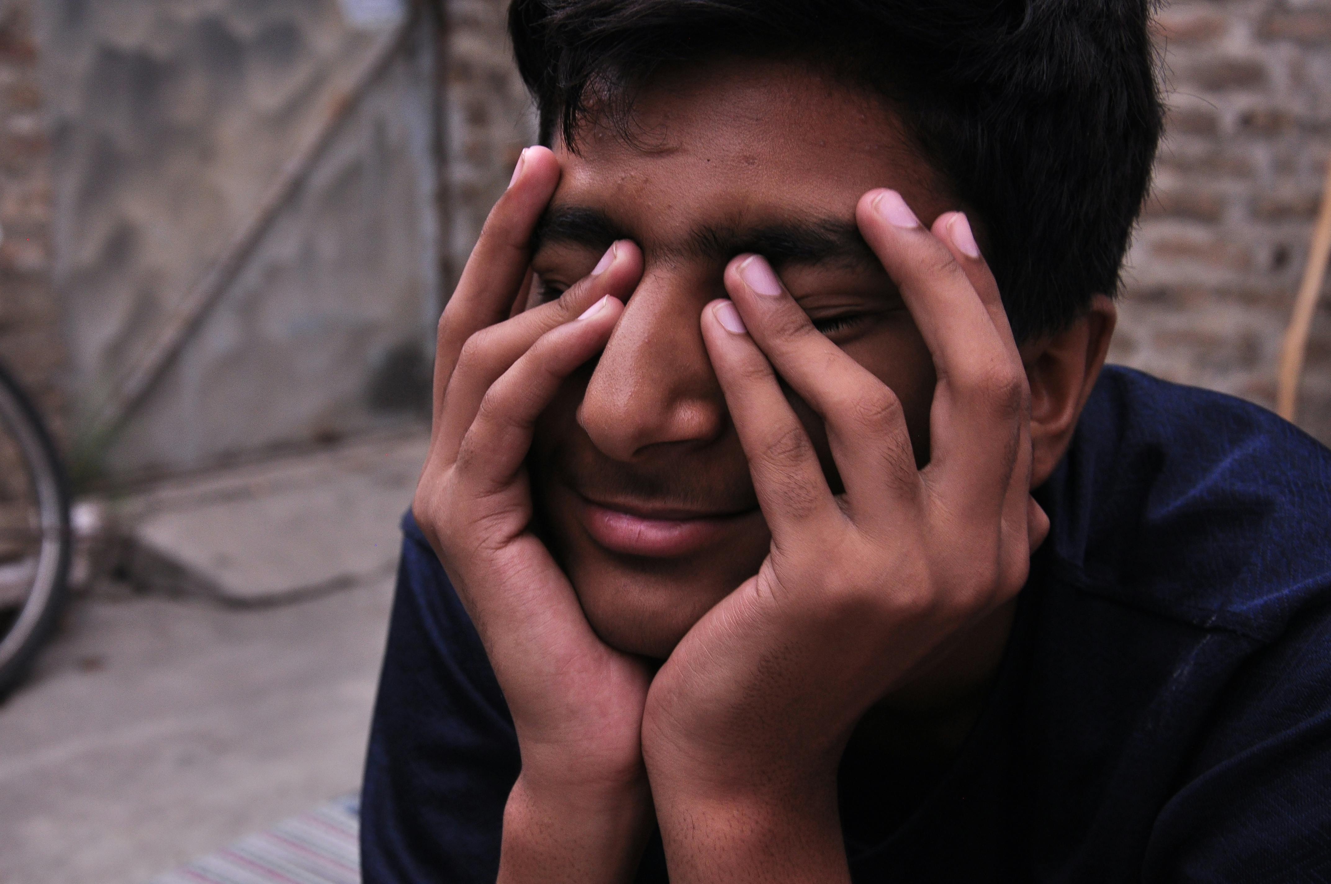 A Man Holding His Face · Free Stock Photo