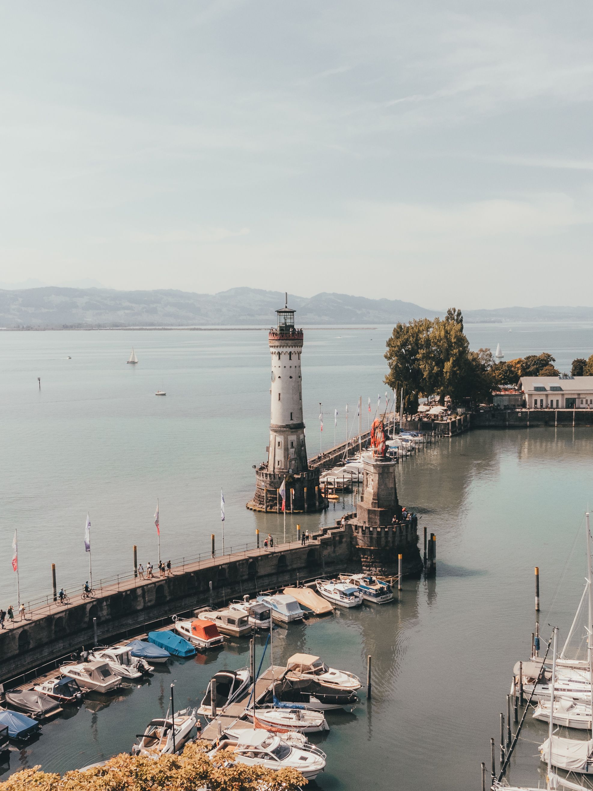 Lighthouse and Motorboats in Bay · Free Stock Photo