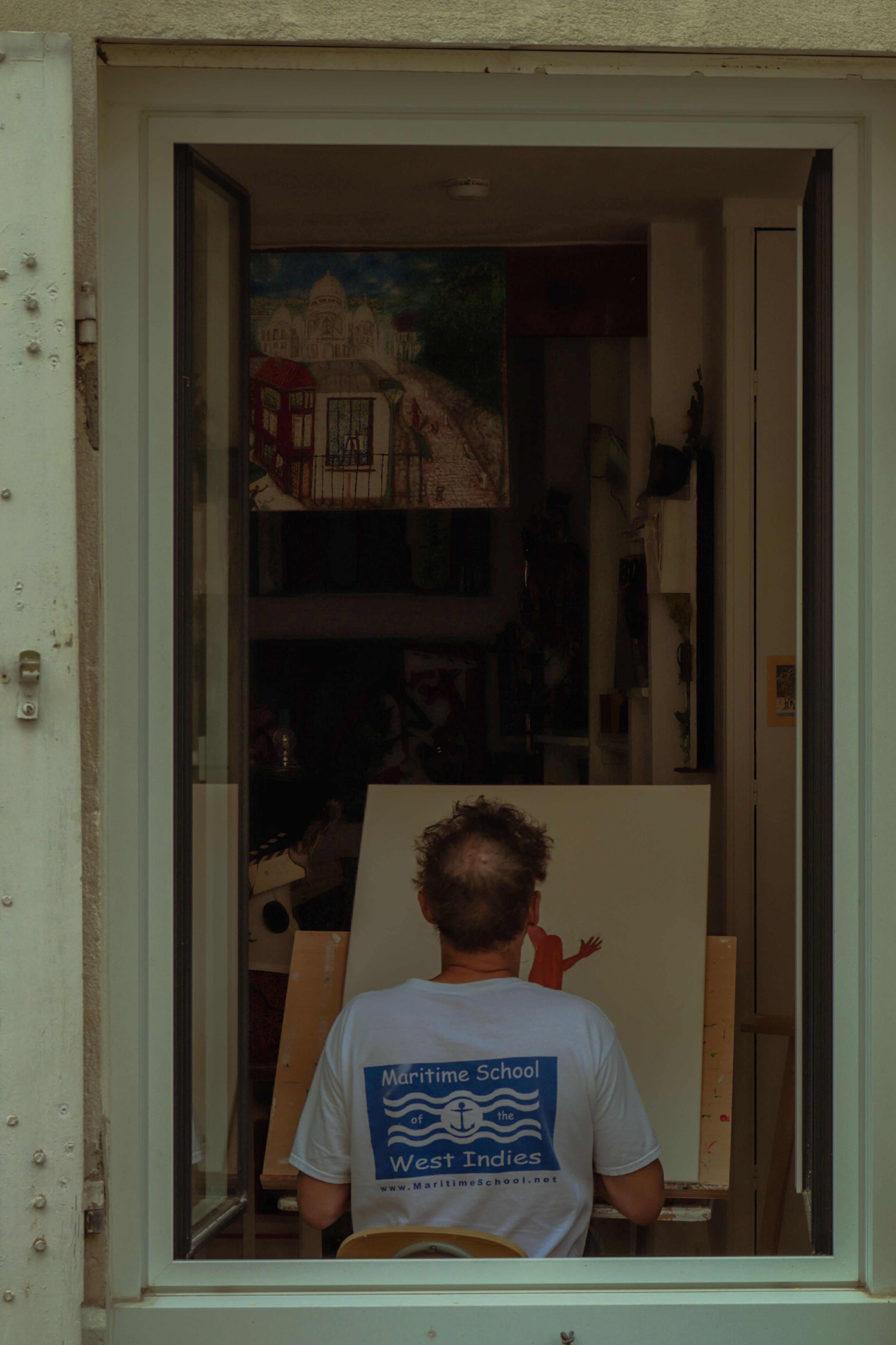 Back View of a Painter Painting on a Canvas · Free Stock Photo