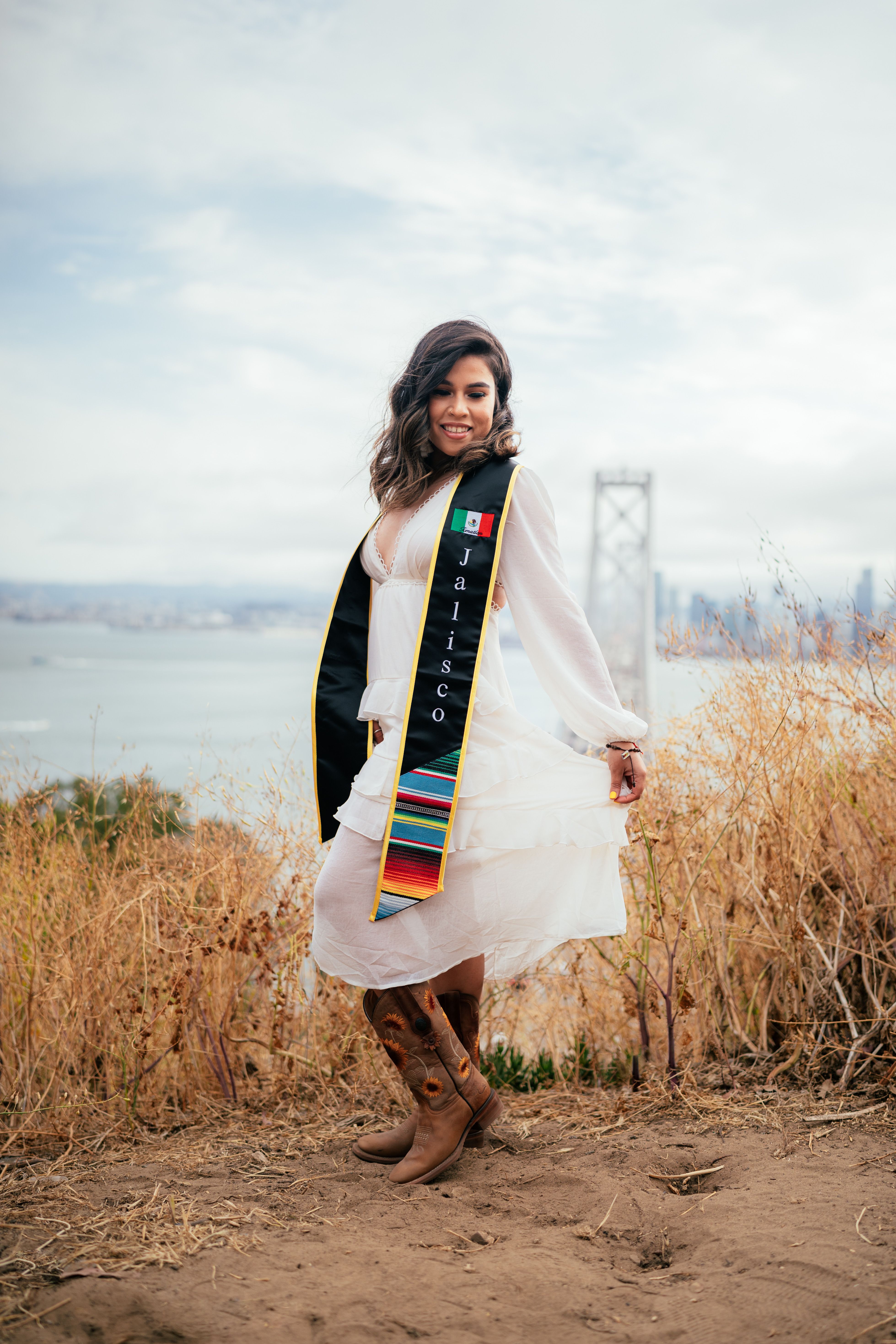 Woman in White Long Sleeves Dress Wearing Sash while Standing on Brown ...