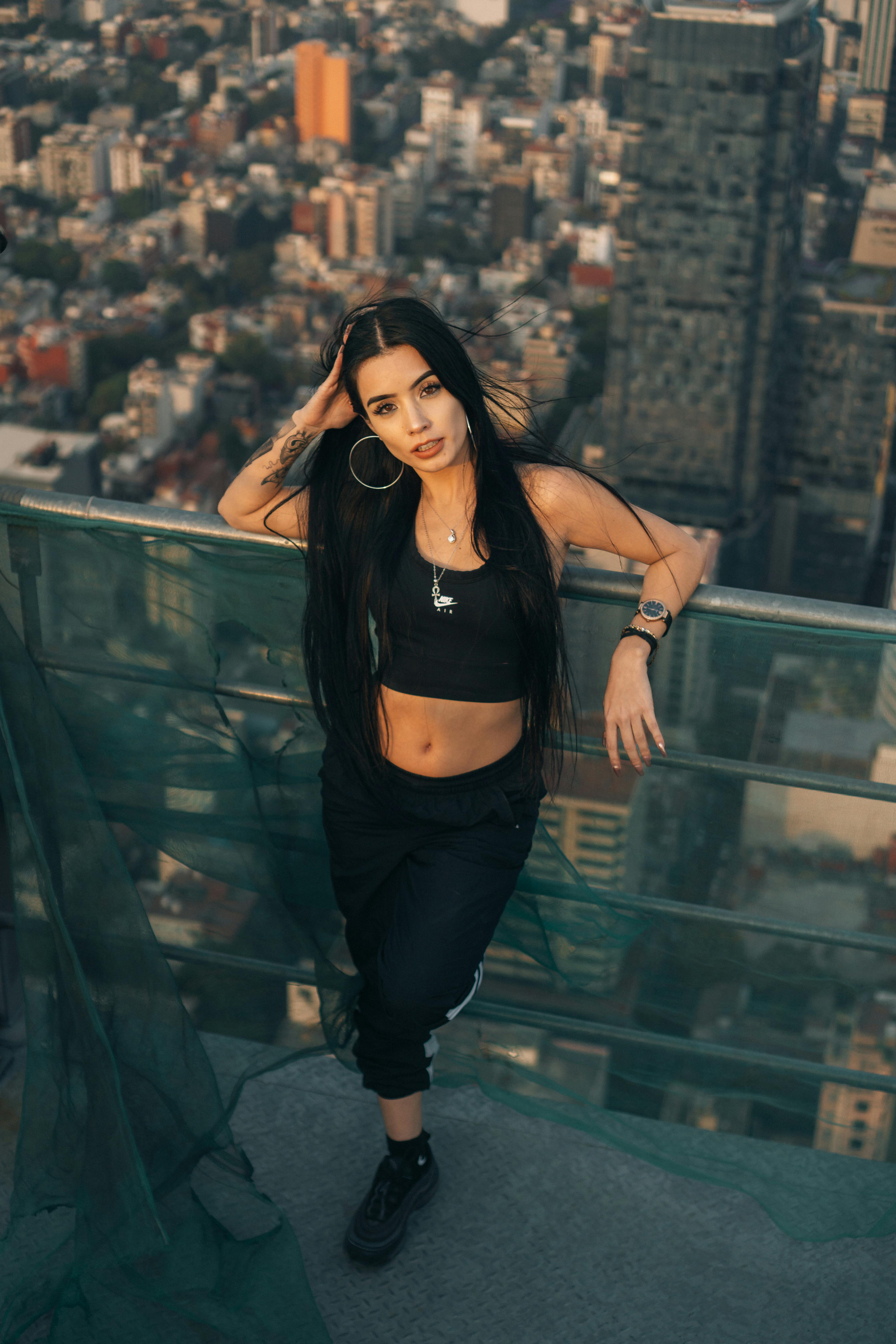 Beautiful Woman Leaning on Railing · Free Stock Photo