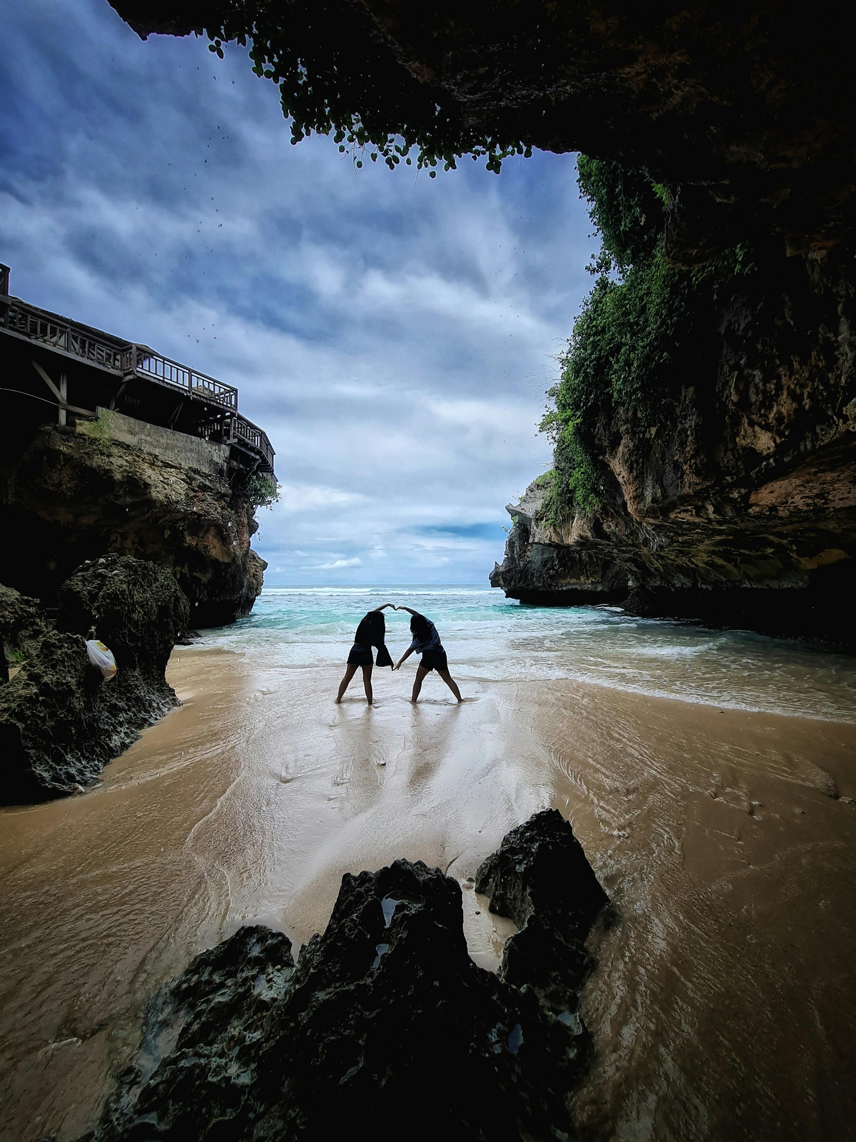 Back View Shot of People Posing on the Shore of the Beach · Free Stock ...