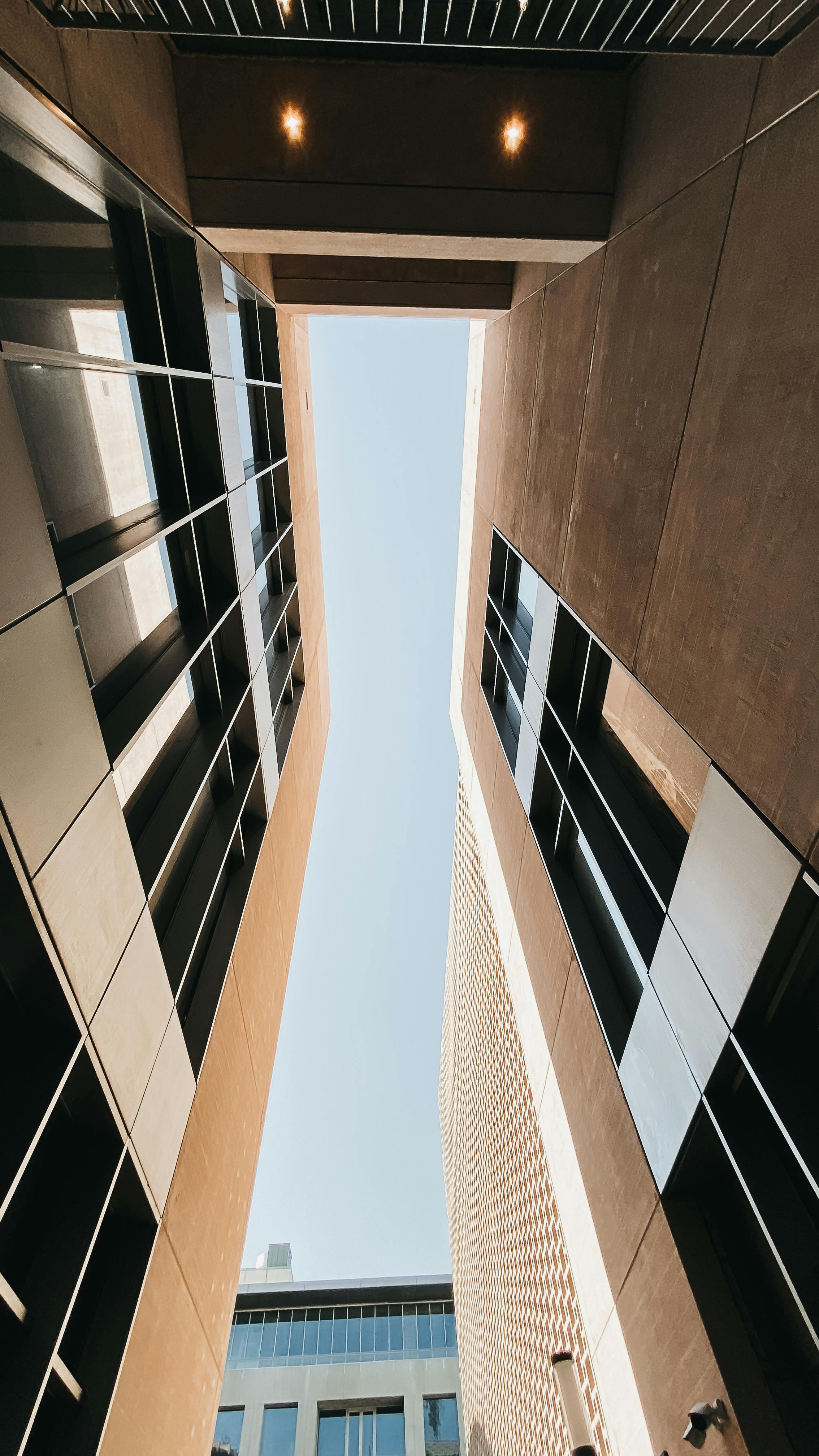 Low Angle Shot of Building Under White Sky · Free Stock Photo
