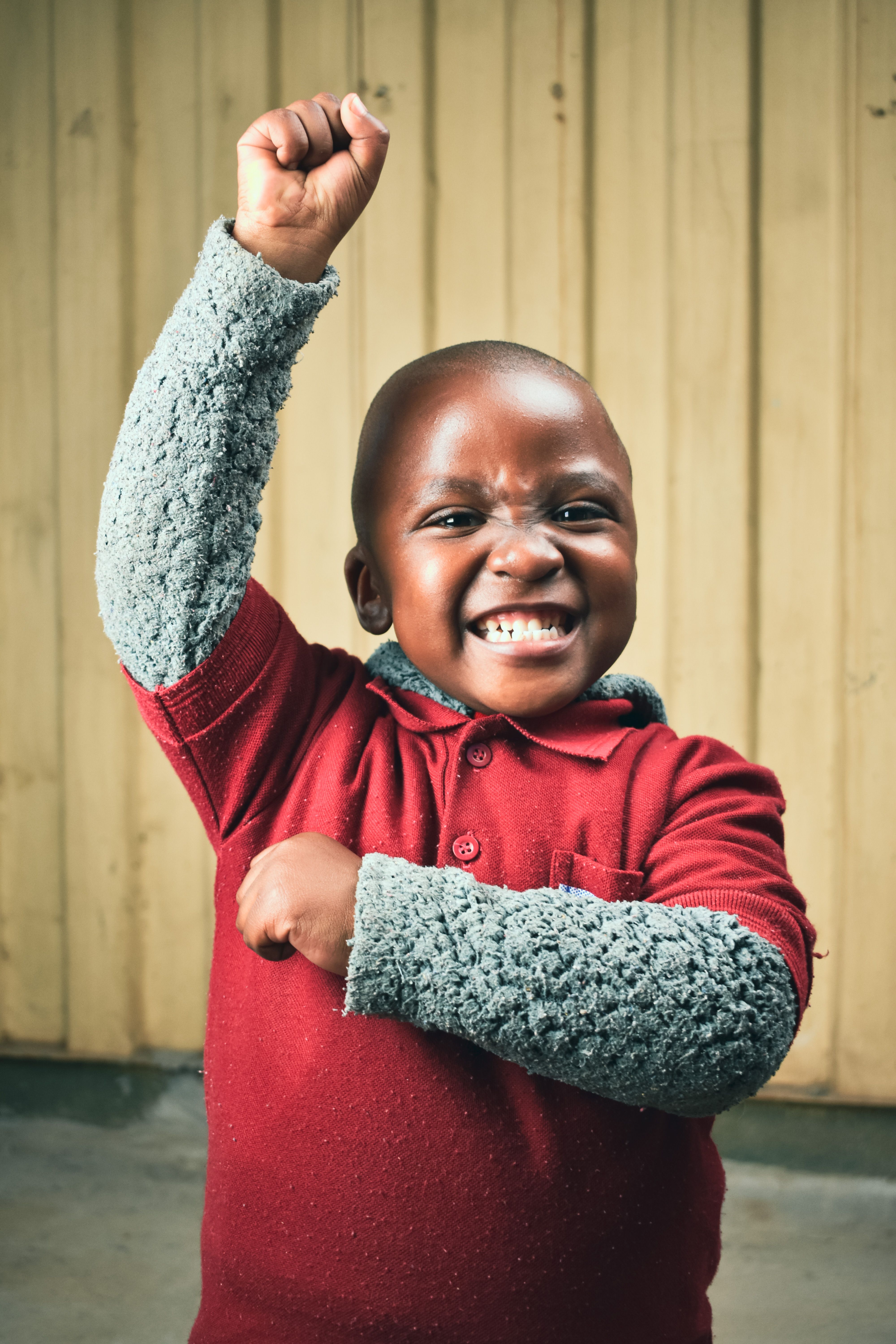 Joyful Child Raising a Fist in Excitement · Free Stock Photo