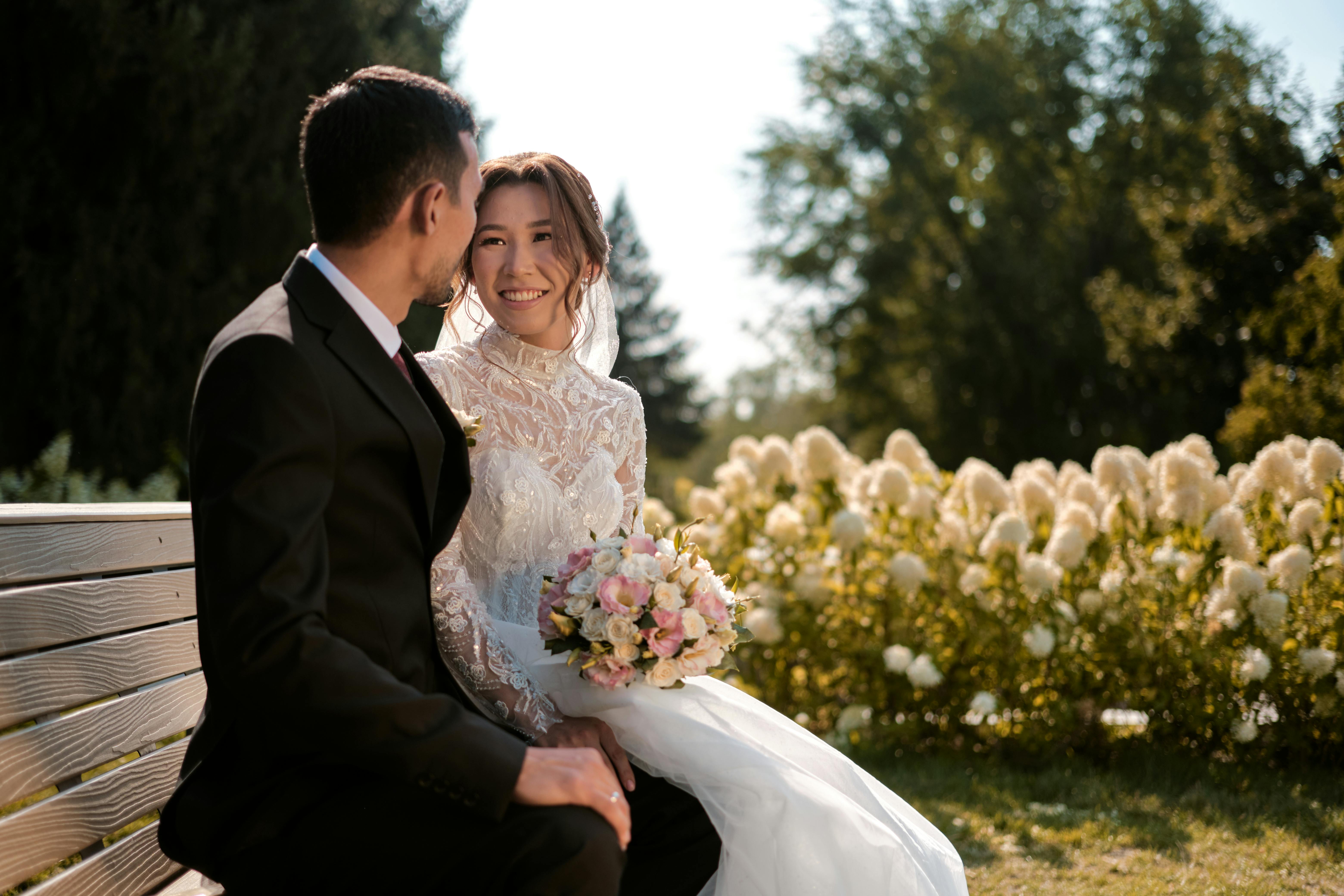 Bride and Groom Sitting on Bench · Free Stock Photo