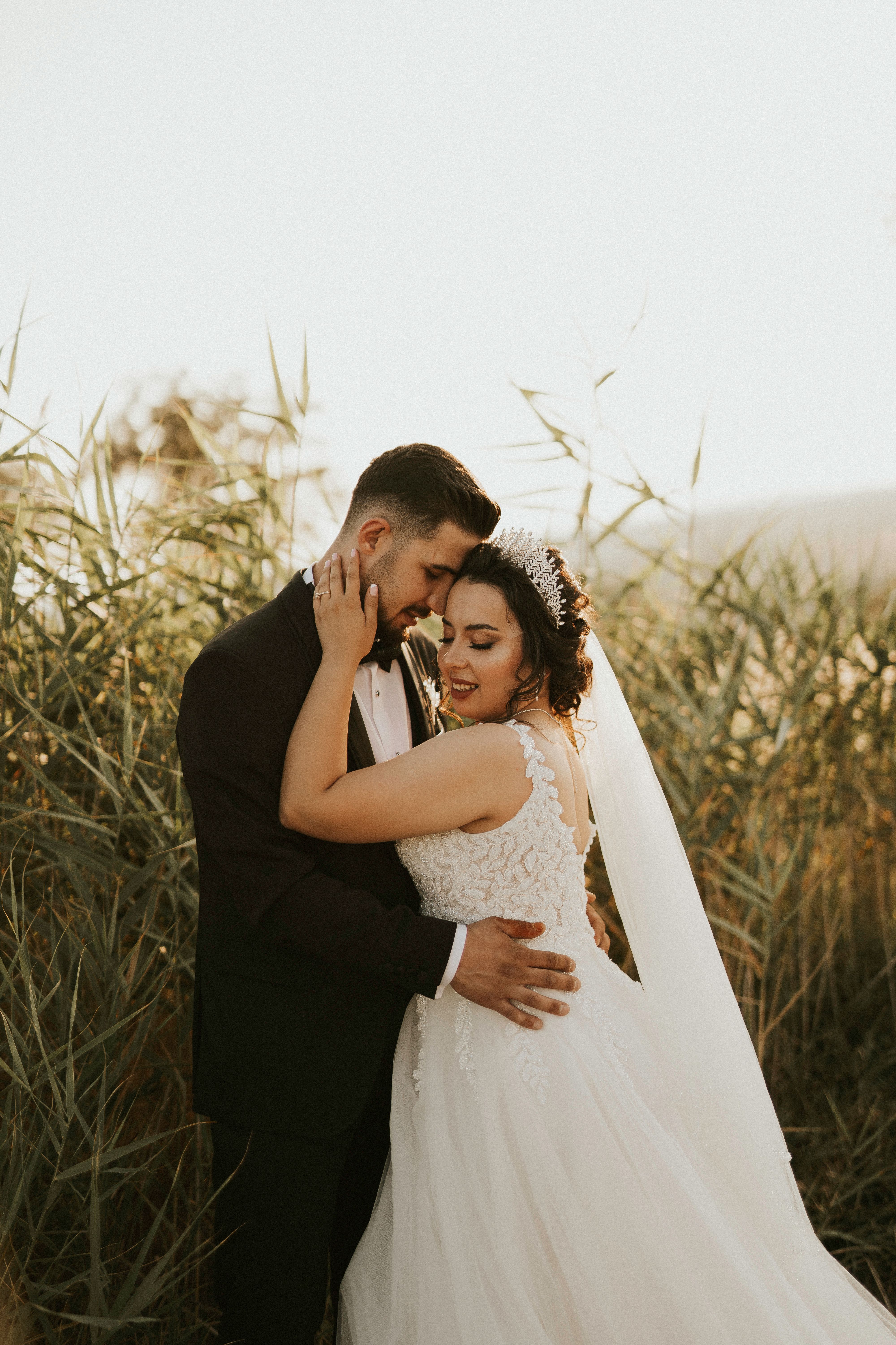 Bridegroom and Bride Embracing by the Crops · Free Stock Photo
