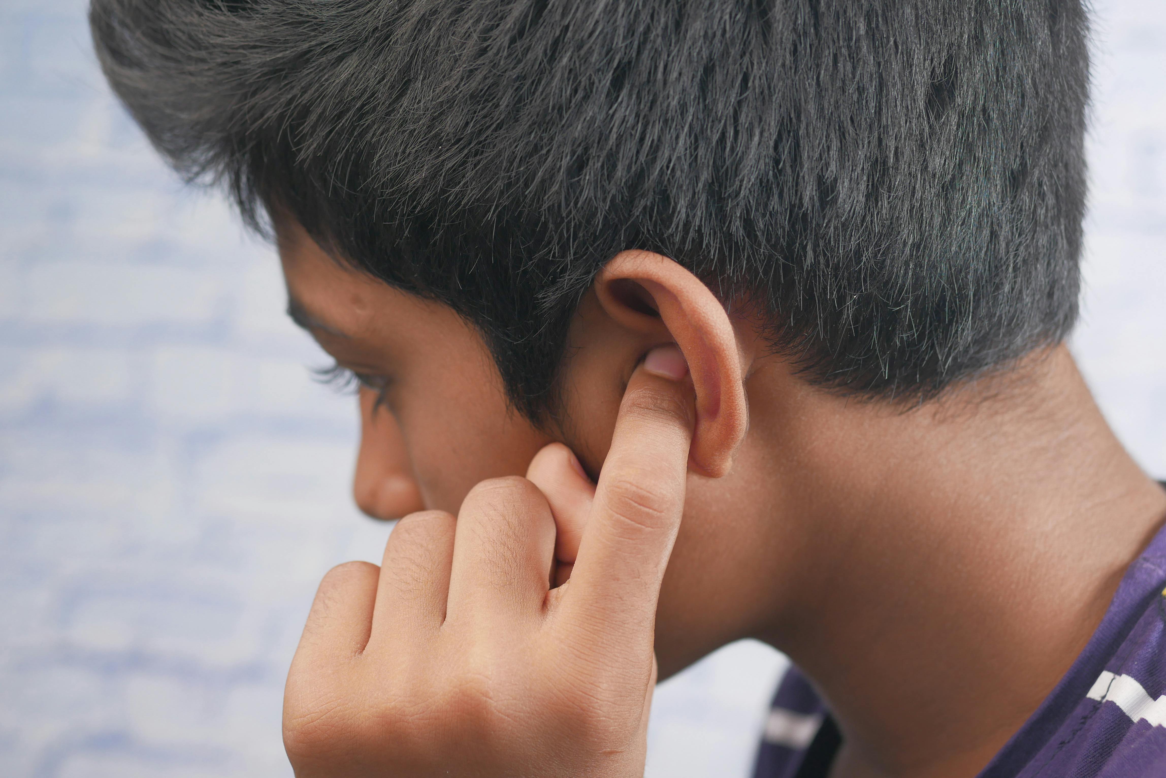 A Boy Covering His Ear · Free Stock Photo