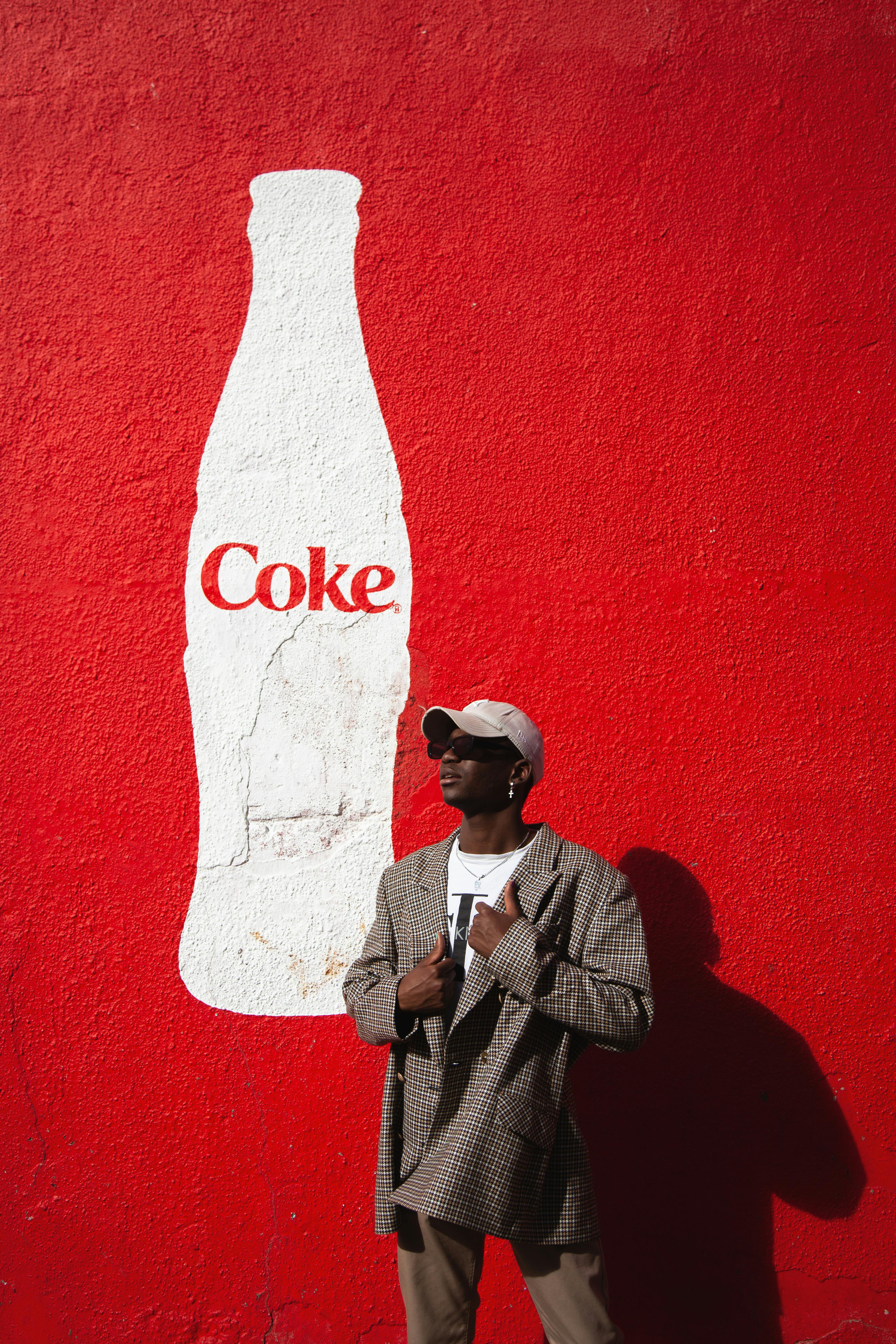 Model Posing against Coke Mural · Free Stock Photo