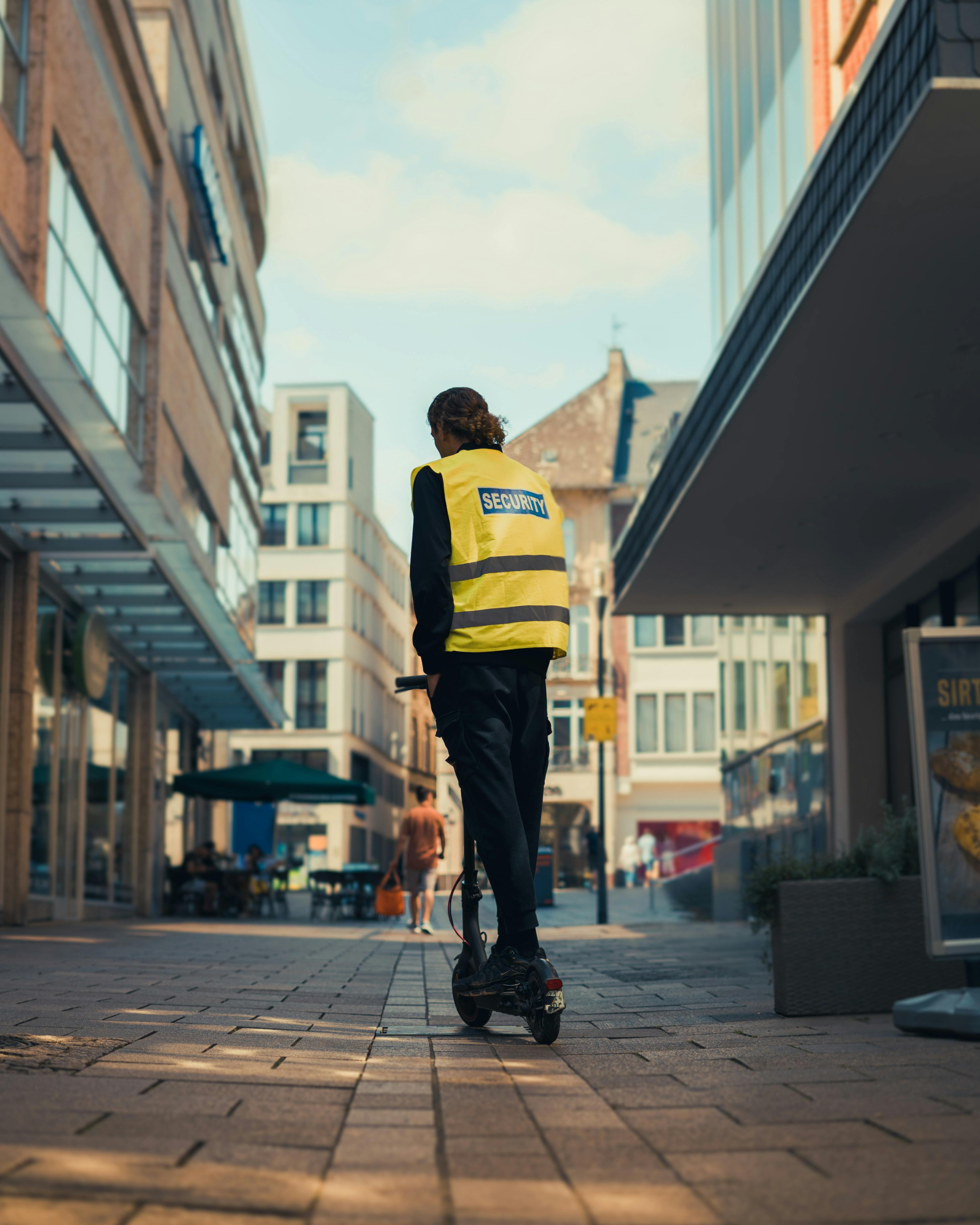 Photo of Person Riding a Scooted on Sidewalk · Free Stock Photo