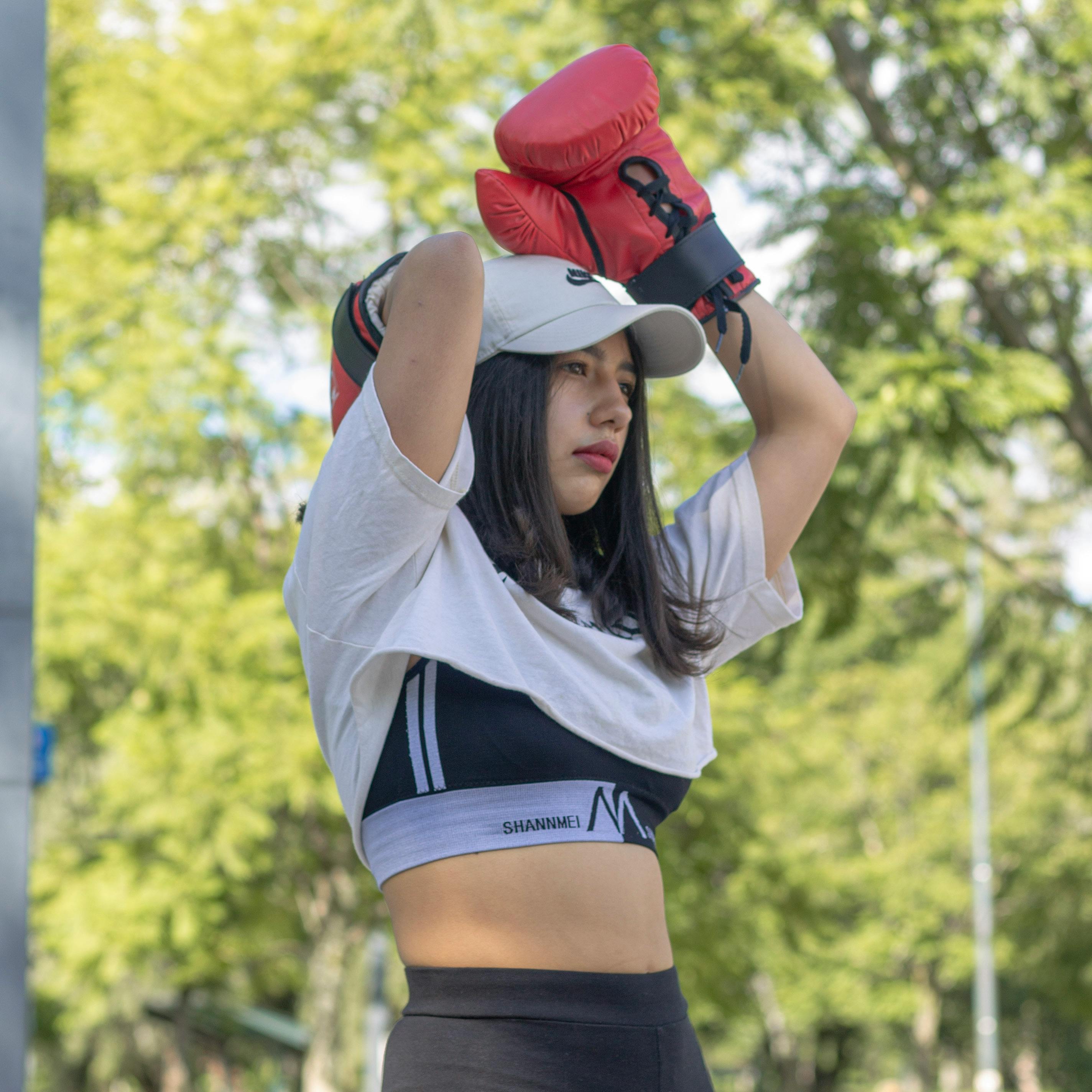 Woman in White Cap Wearing Boxing Gloves · Free Stock Photo
