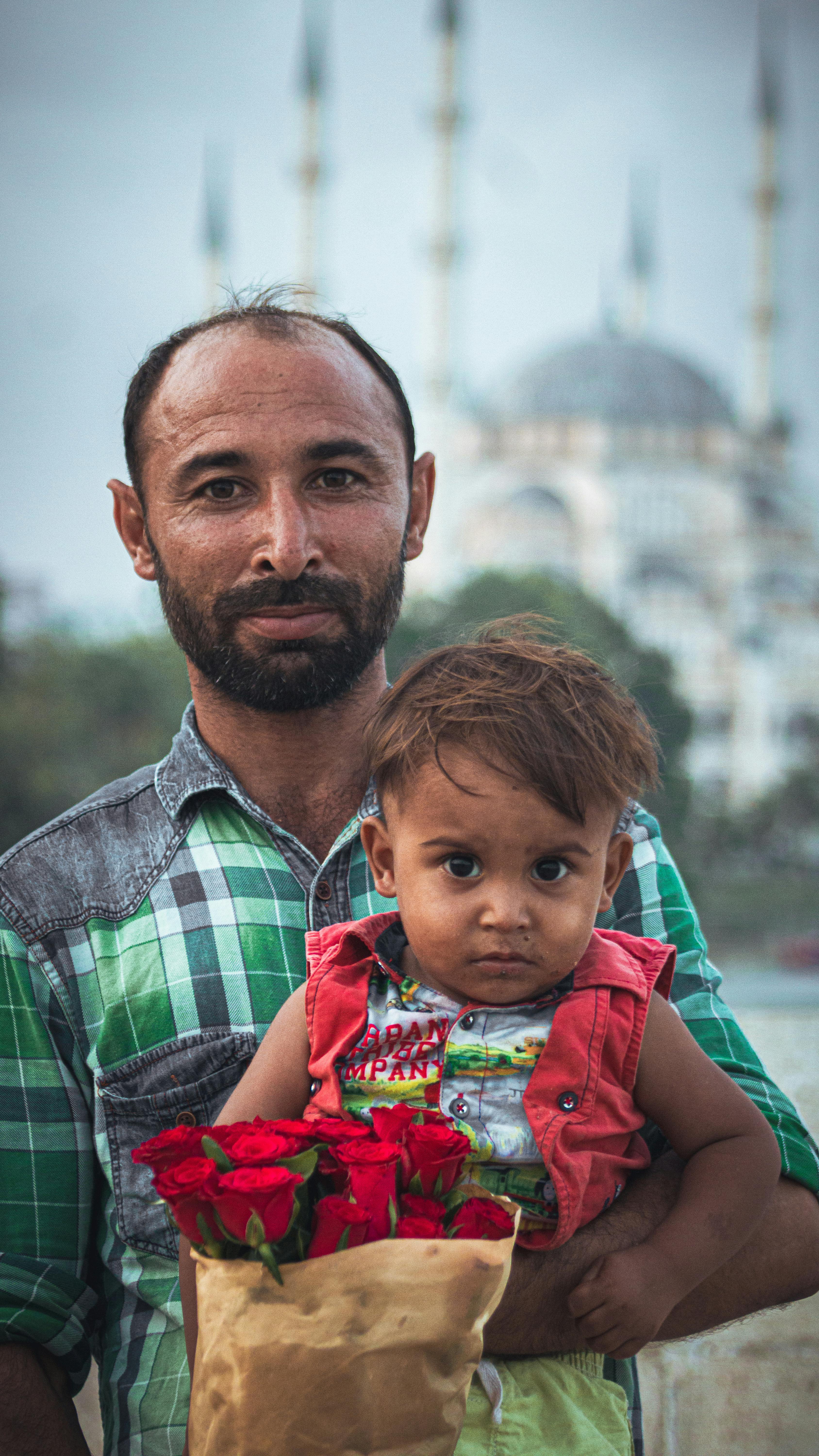 Portrait of a Man with a Baby · Free Stock Photo