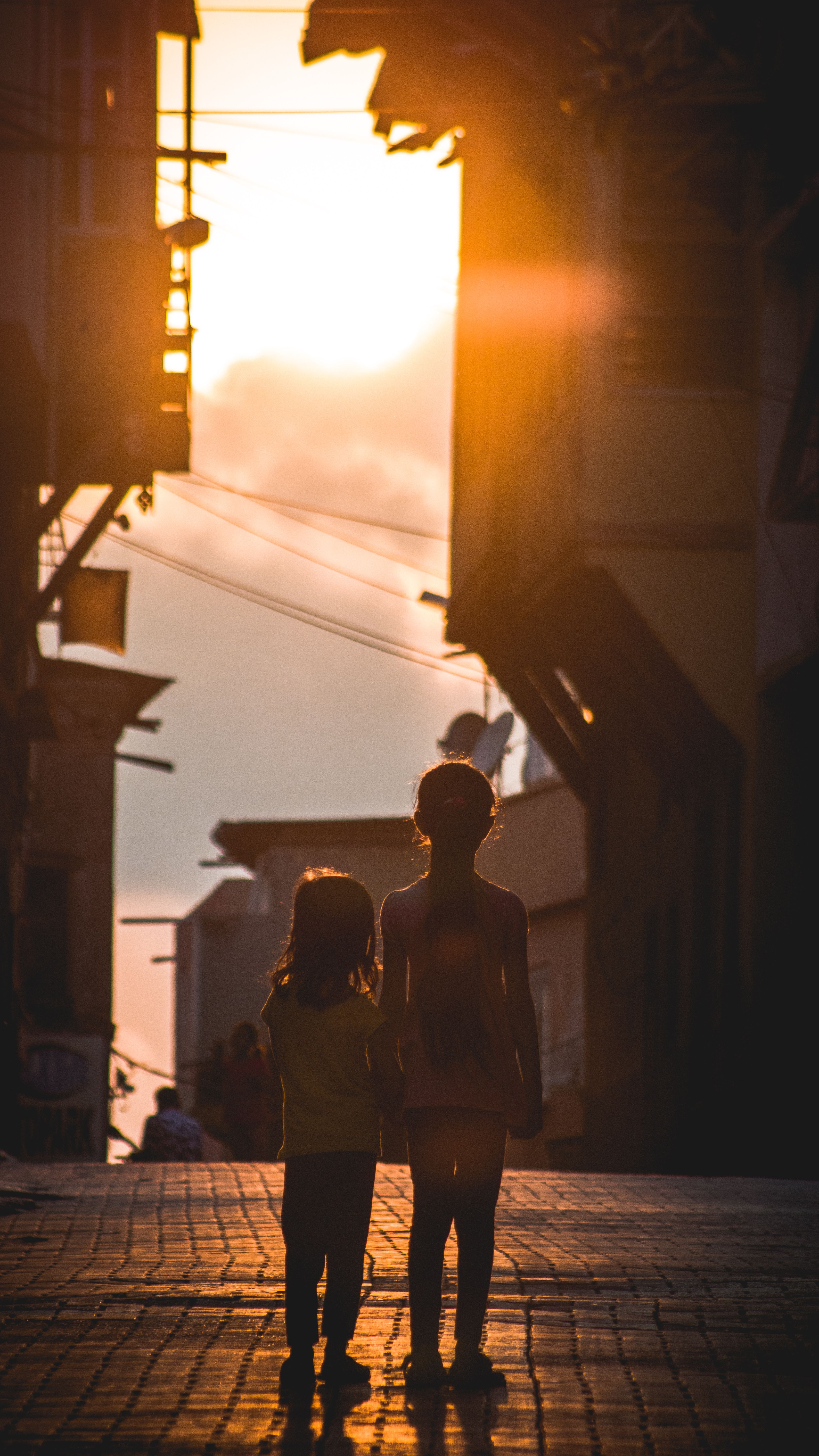 A Back View of Kids Standing on the Street · Free Stock Photo