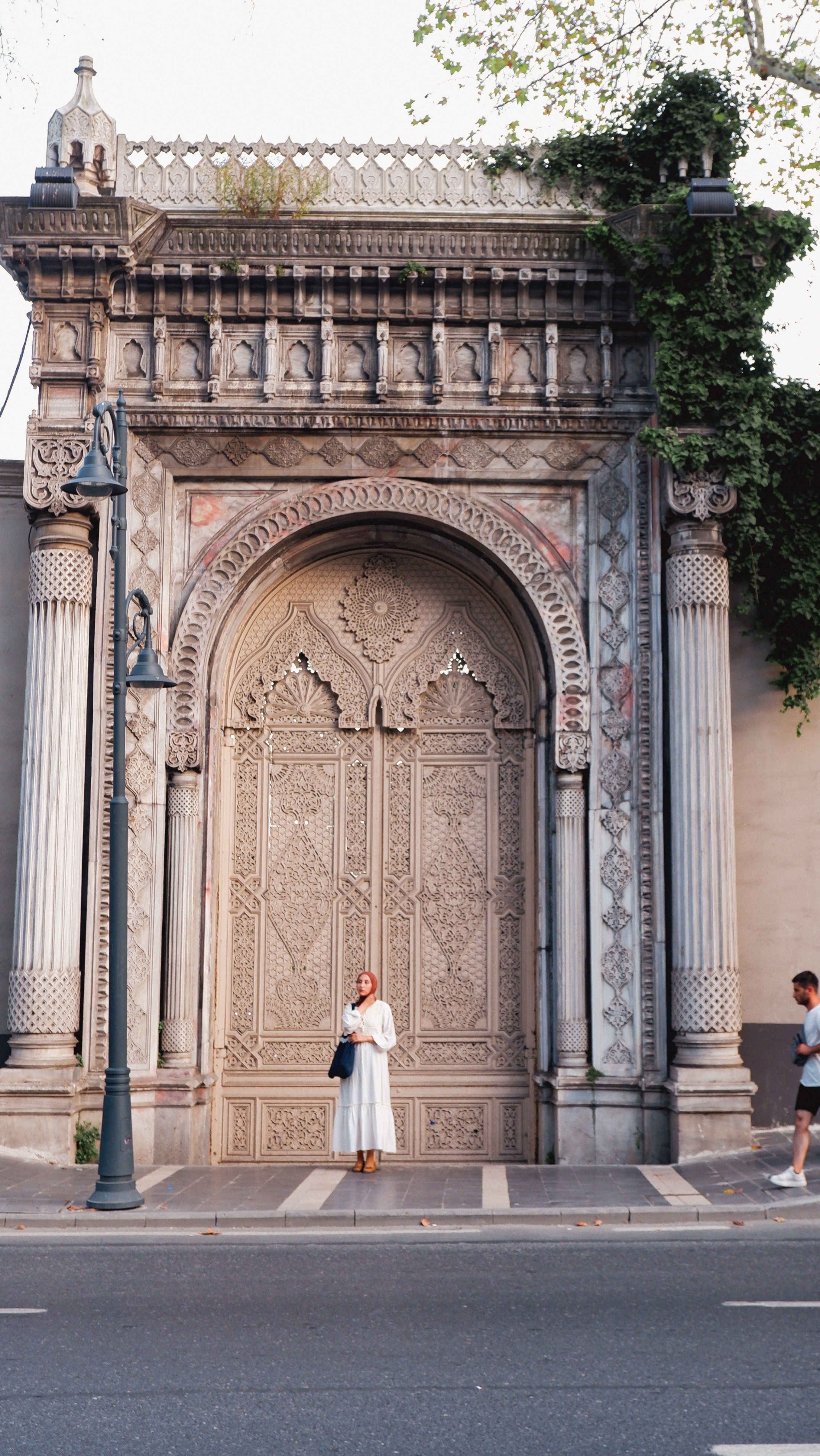 Woman Standing near Traditional Building on Street · Free Stock Photo