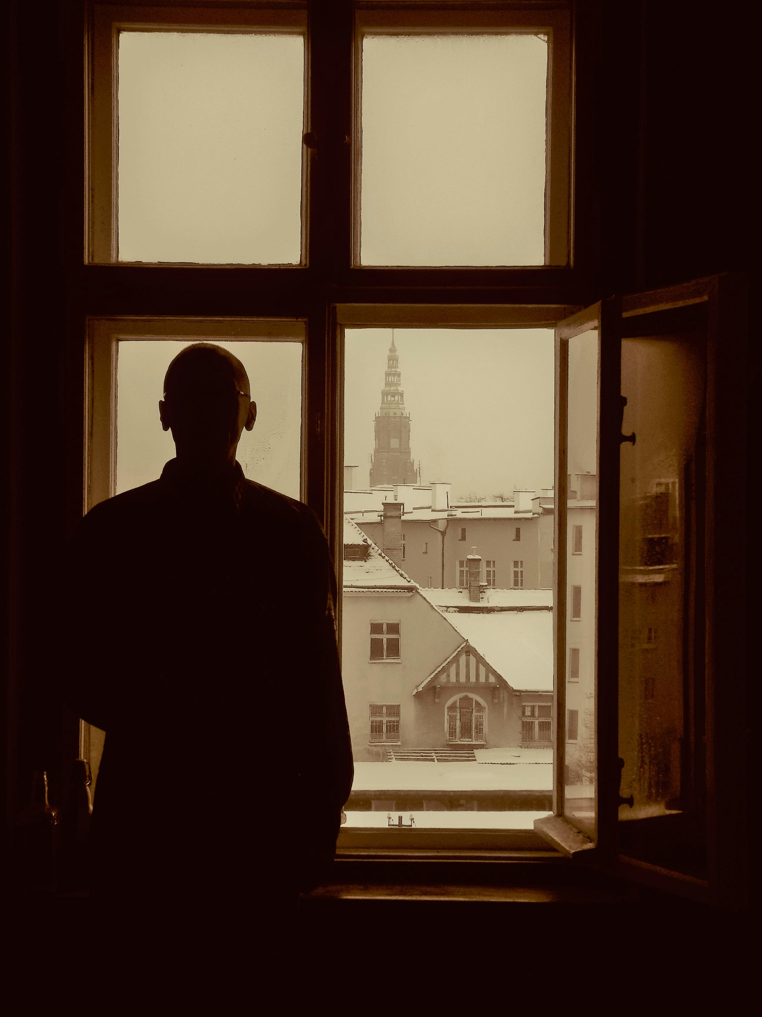 A Man Standing Near Window · Free Stock Photo