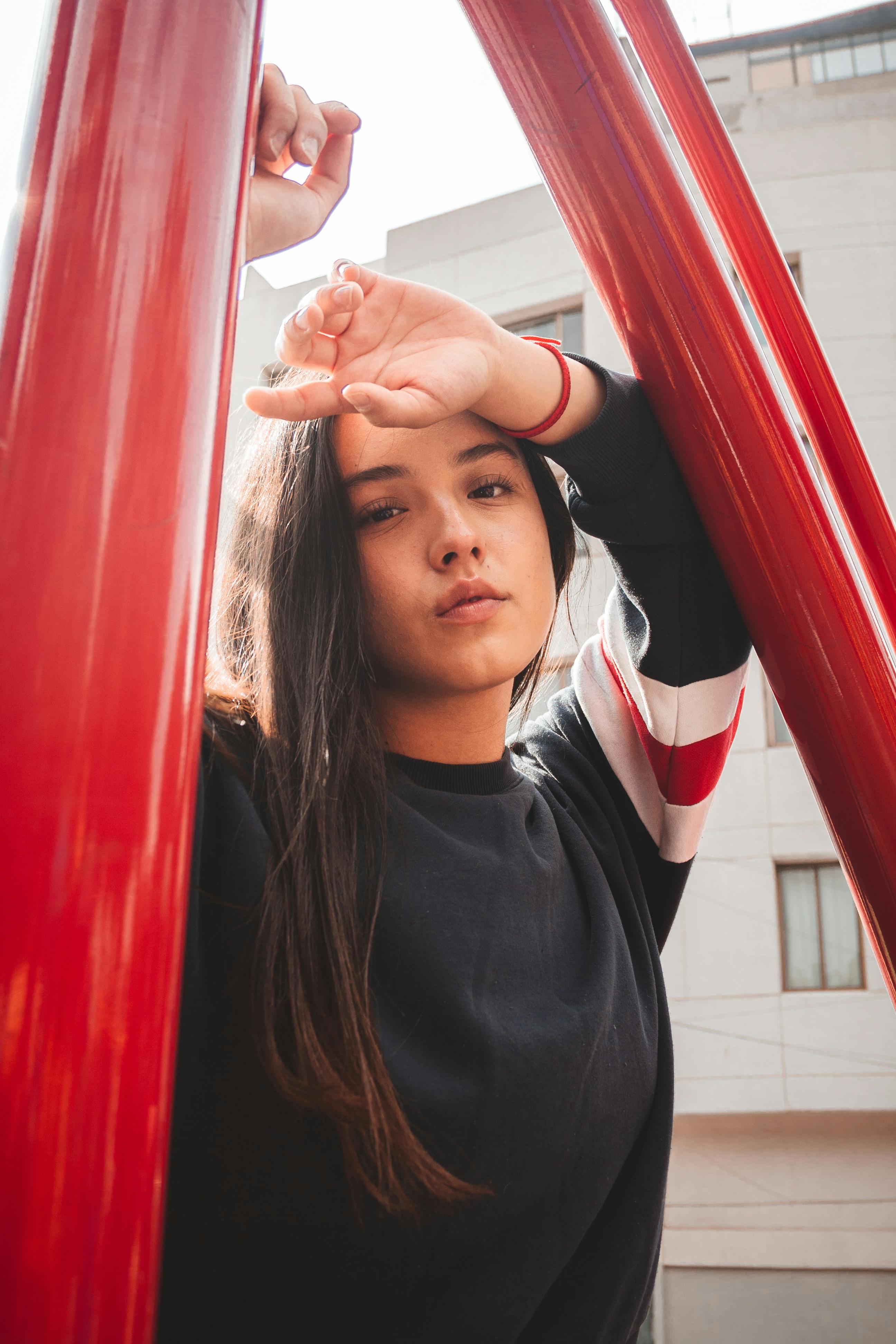 Woman Standing and Leaning on the Railing at an Airport Terminal · Free ...