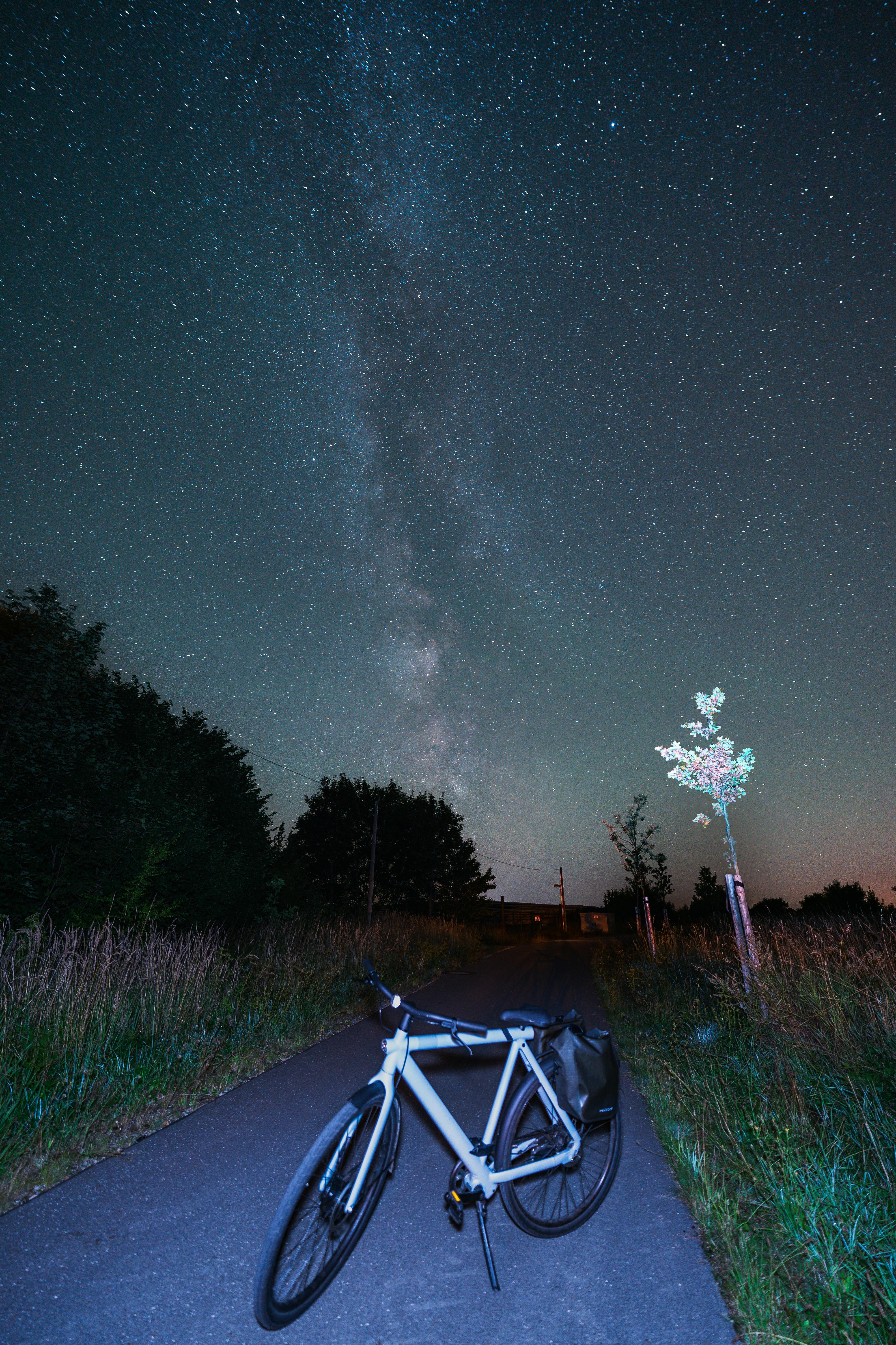 Bicycle Parked on a Road Under a Starry Sky · Free Stock Photo