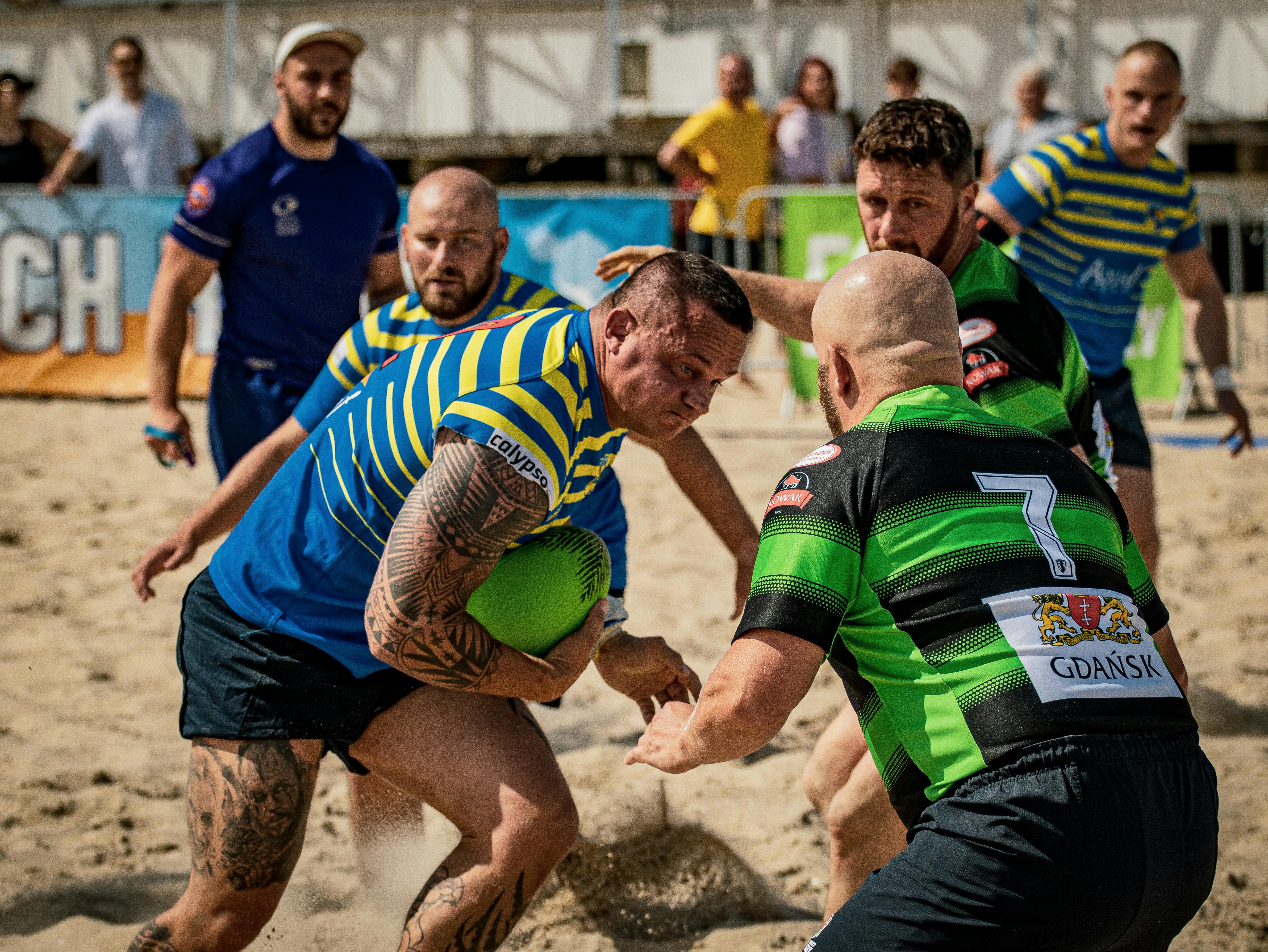 Men Playing Rugby on Sand · Free Stock Photo