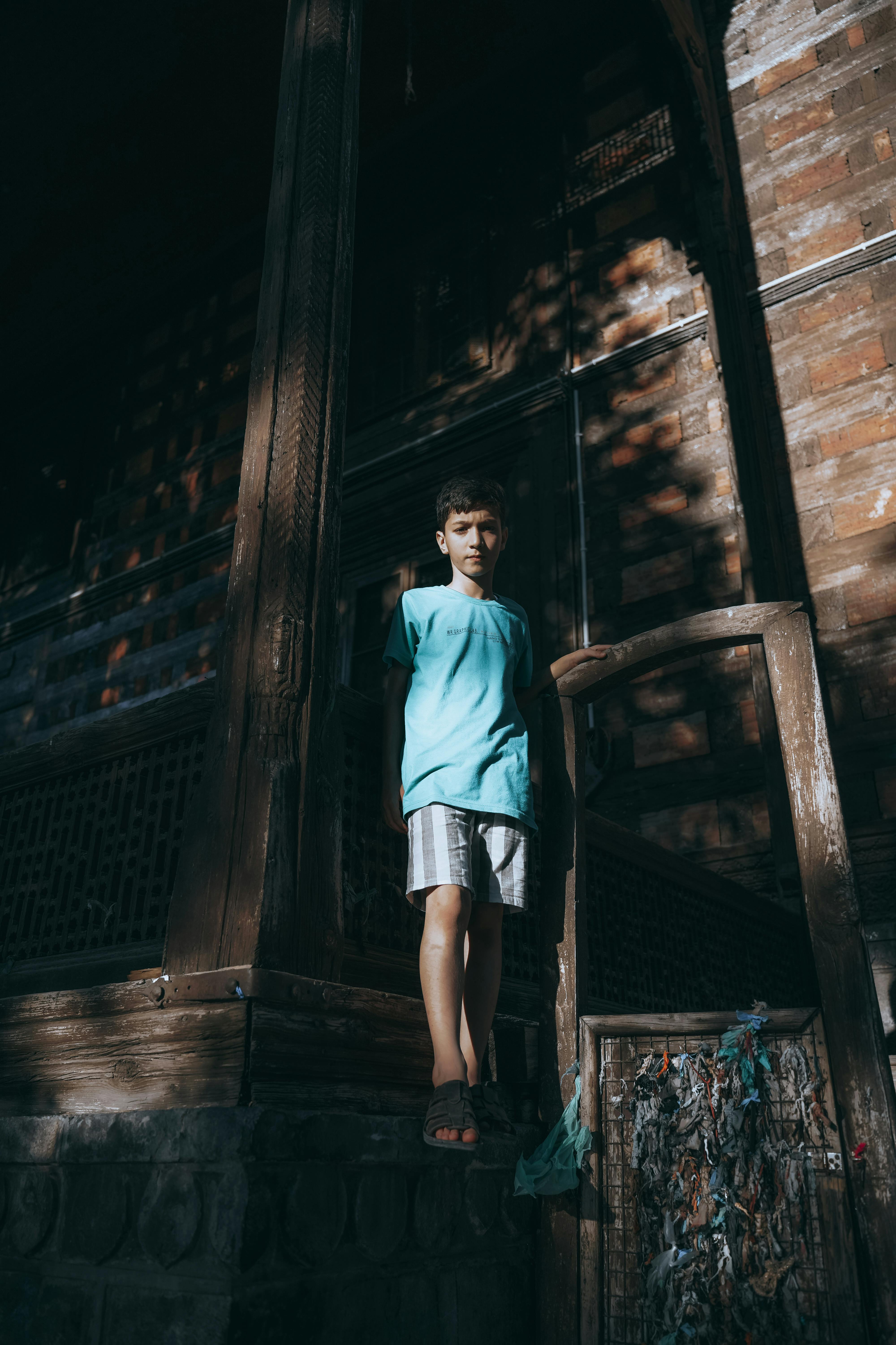 Boy Standing near Old Building · Free Stock Photo