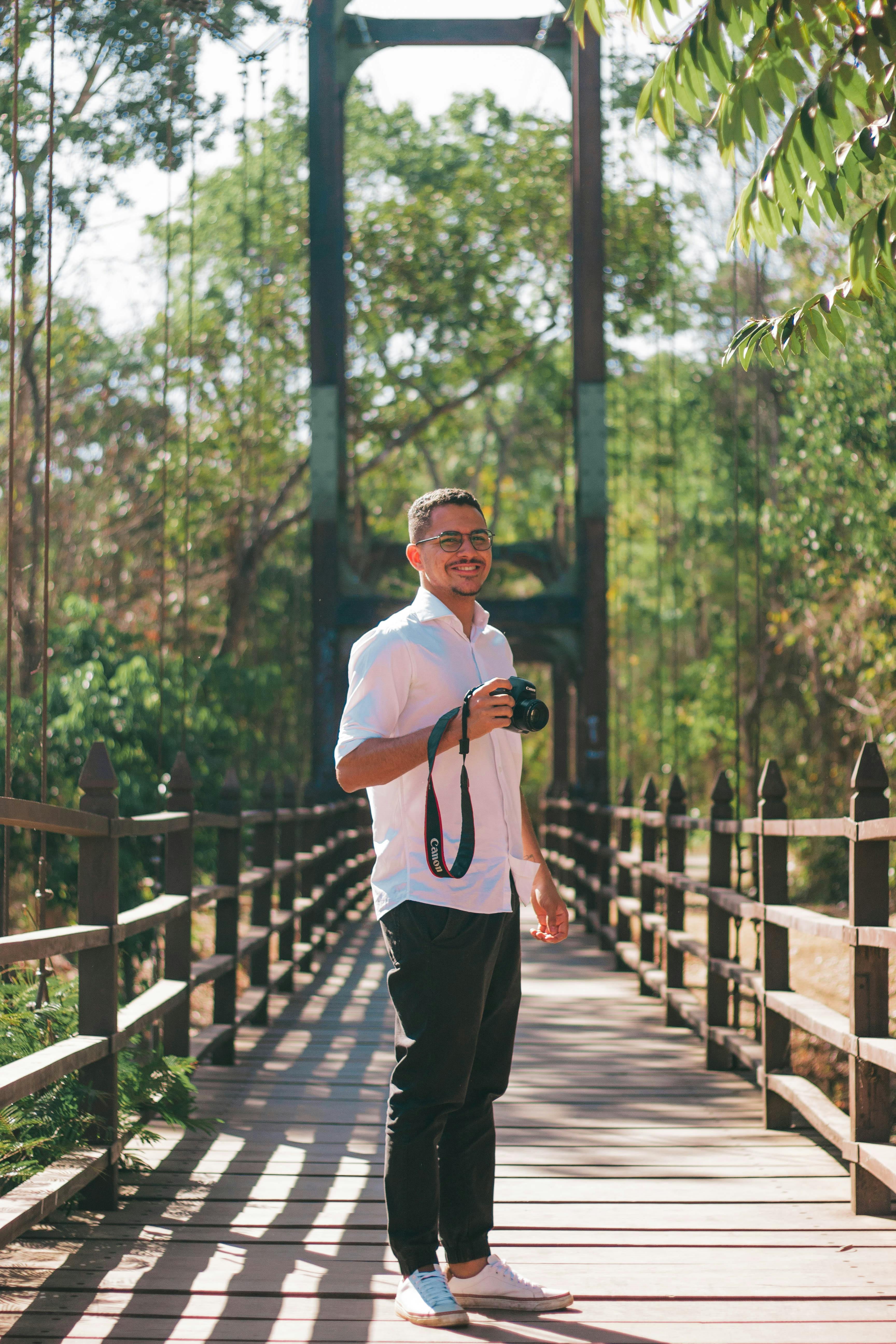 Photo of Man Holding a Dslr Camera · Free Stock Photo