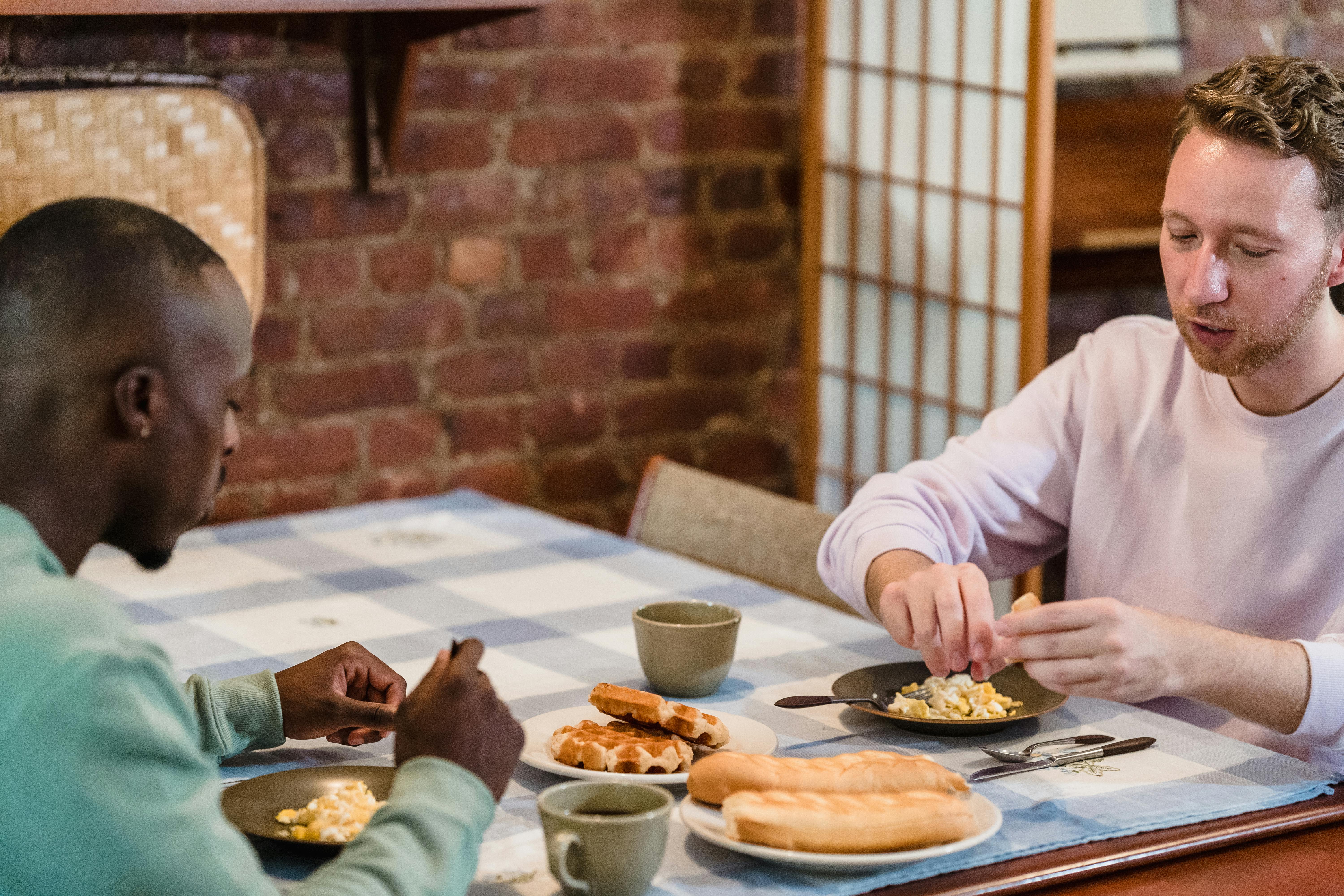 Two Men Eating Breakfast · Free Stock Photo
