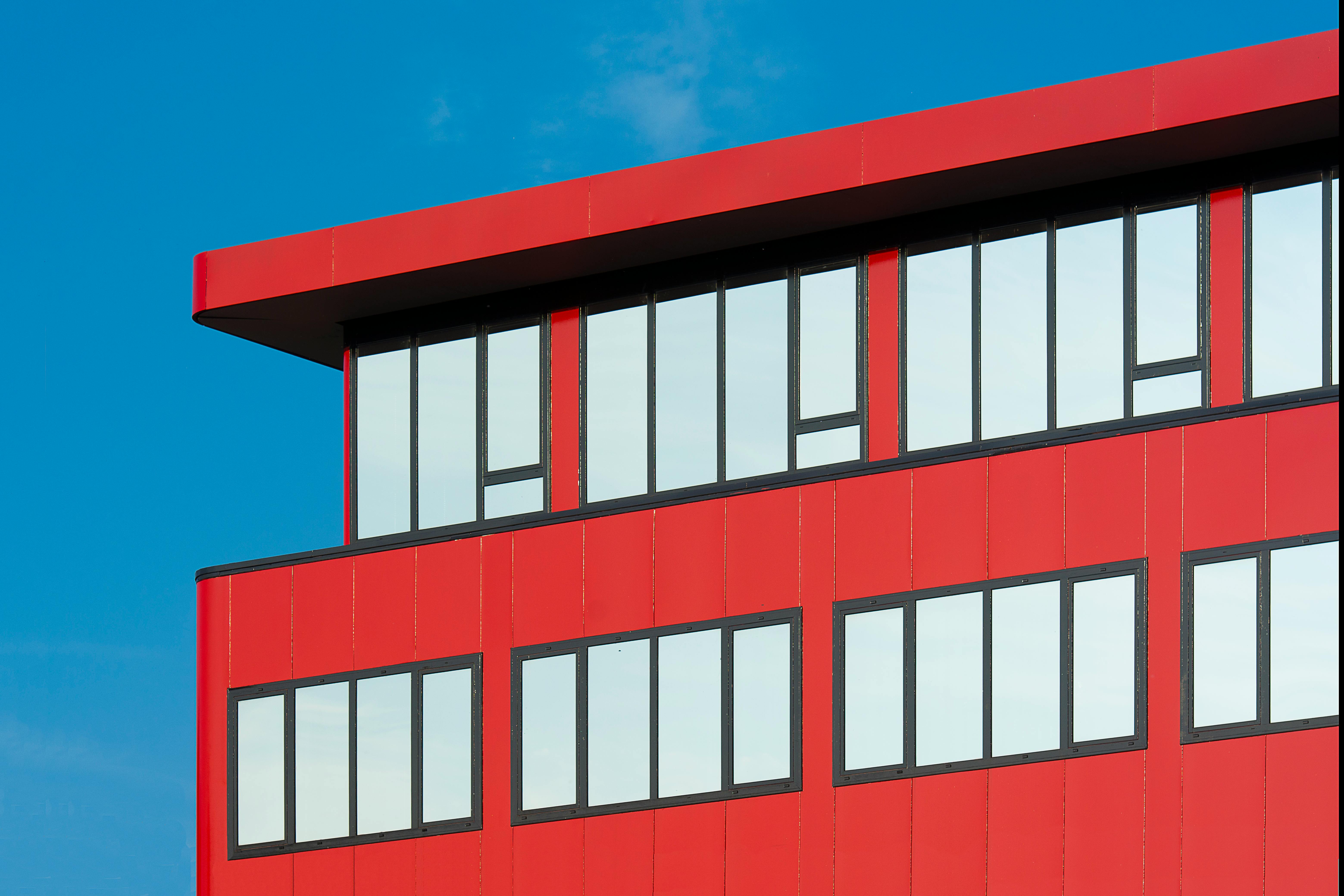 Glass Window on Red Concrete Building Under Blue Sky · Free Stock Photo