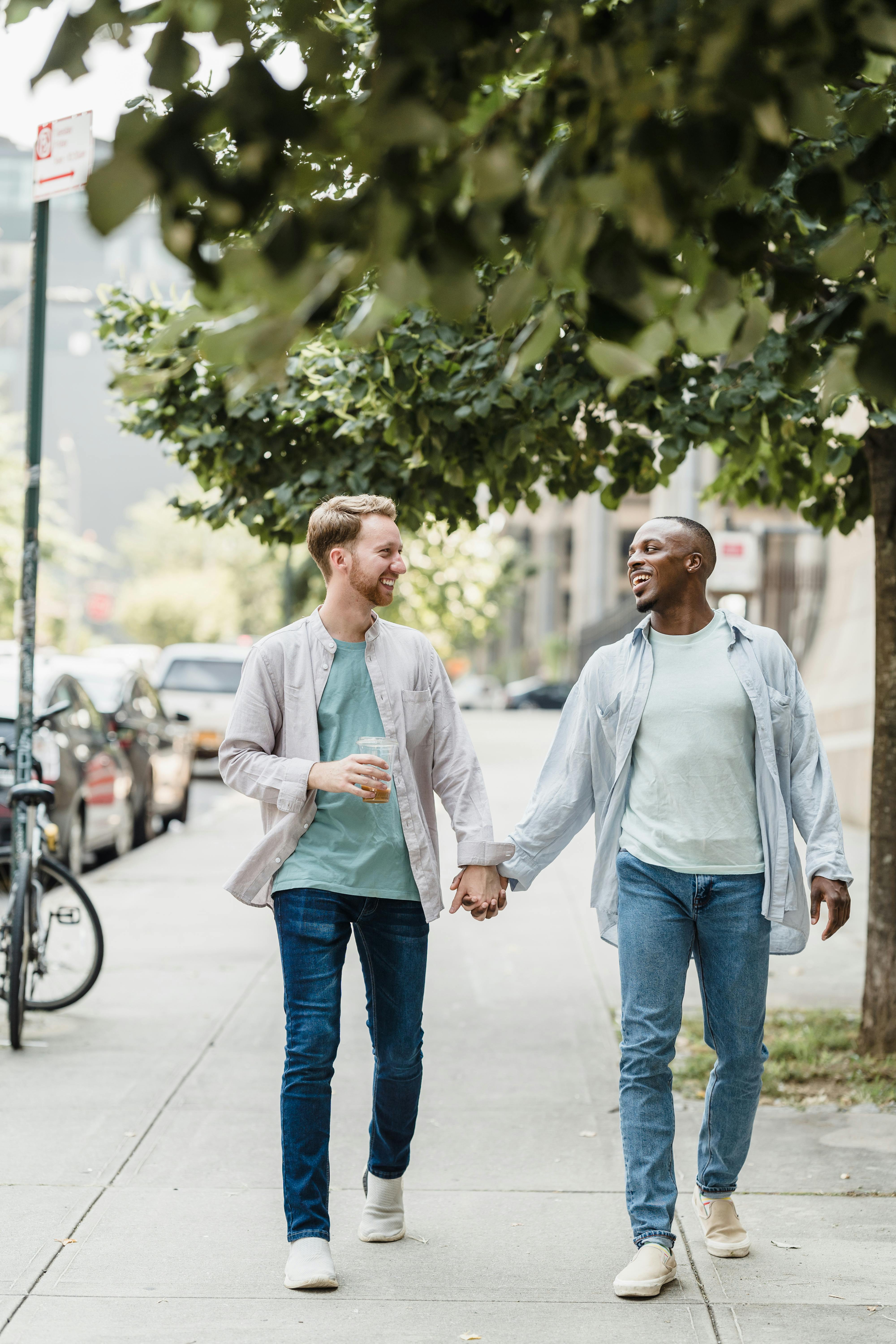 Two Men Holding Hands on the Street · Free Stock Photo