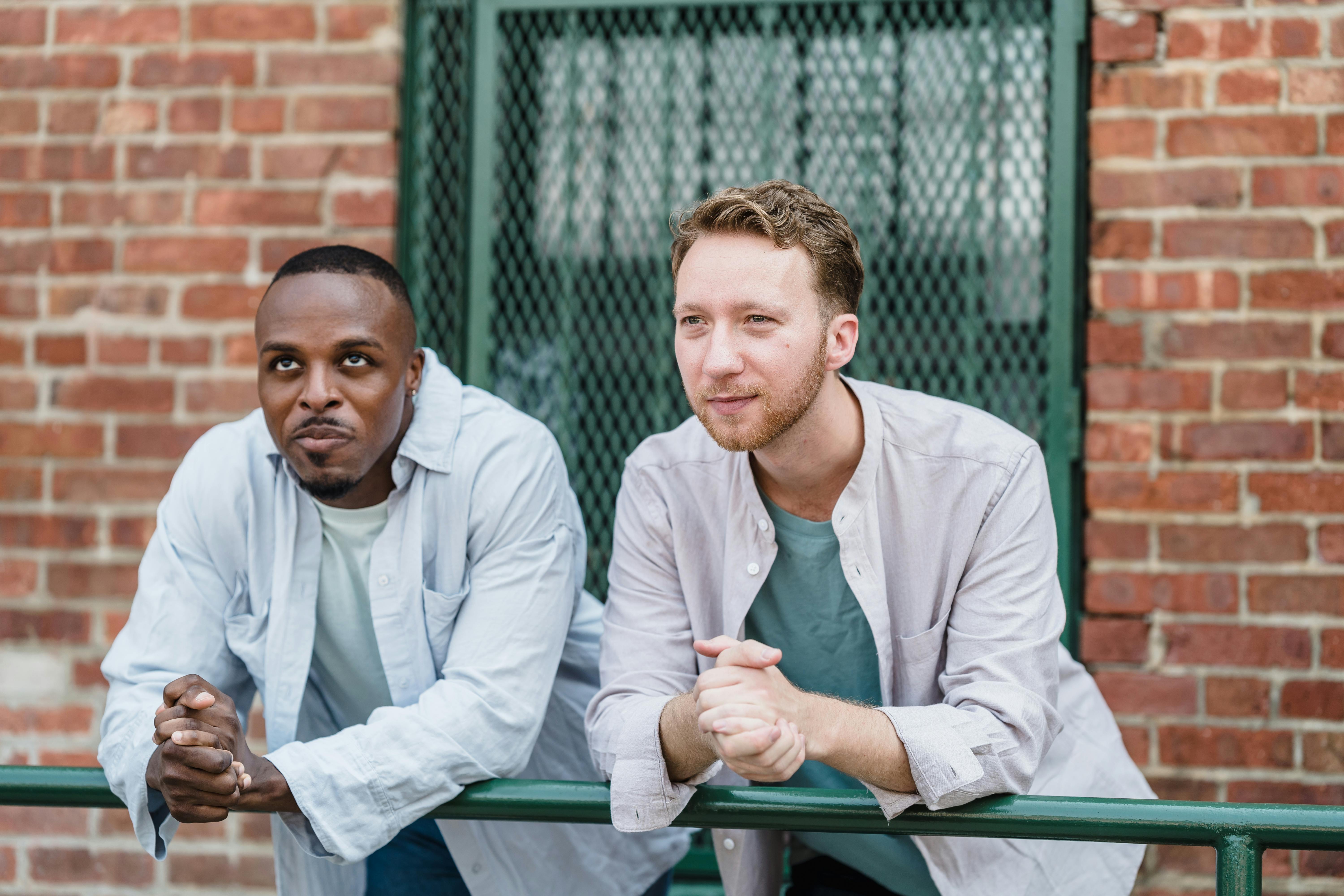 Two Men Leaning on the Railing · Free Stock Photo