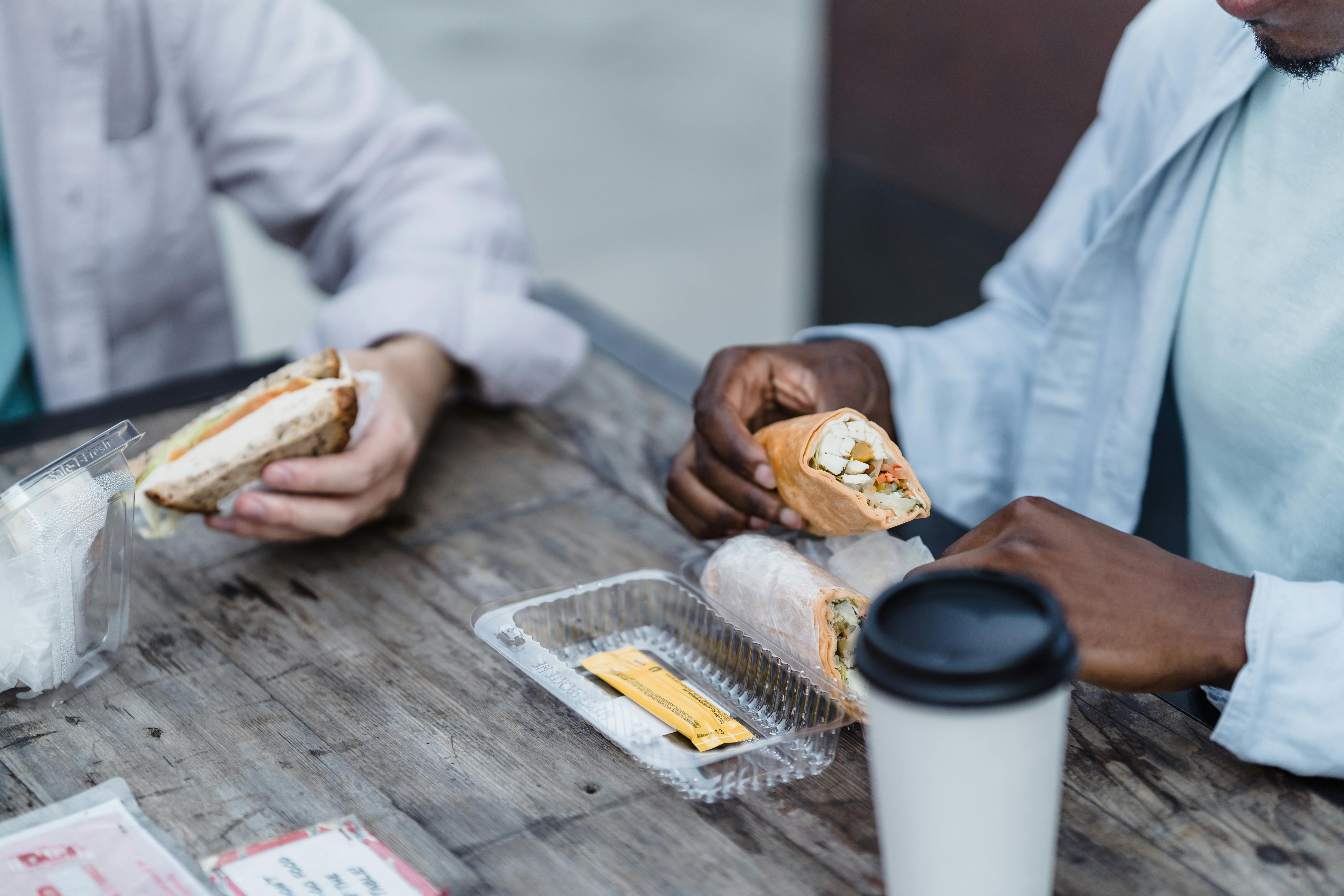 Close-up of Two Men Eating Lunch · Free Stock Photo