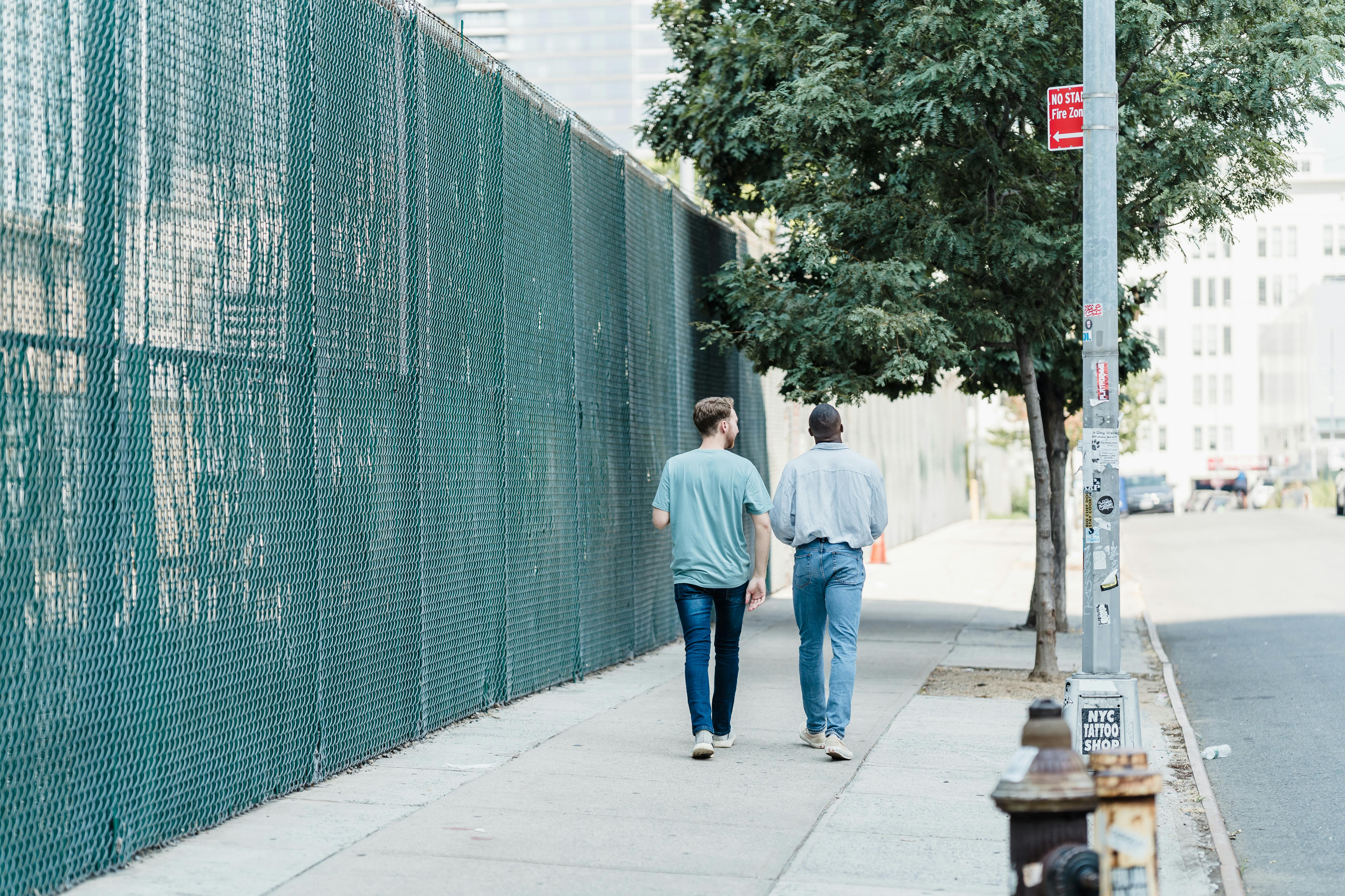 Couple Walking on Sidewalk Together · Free Stock Photo