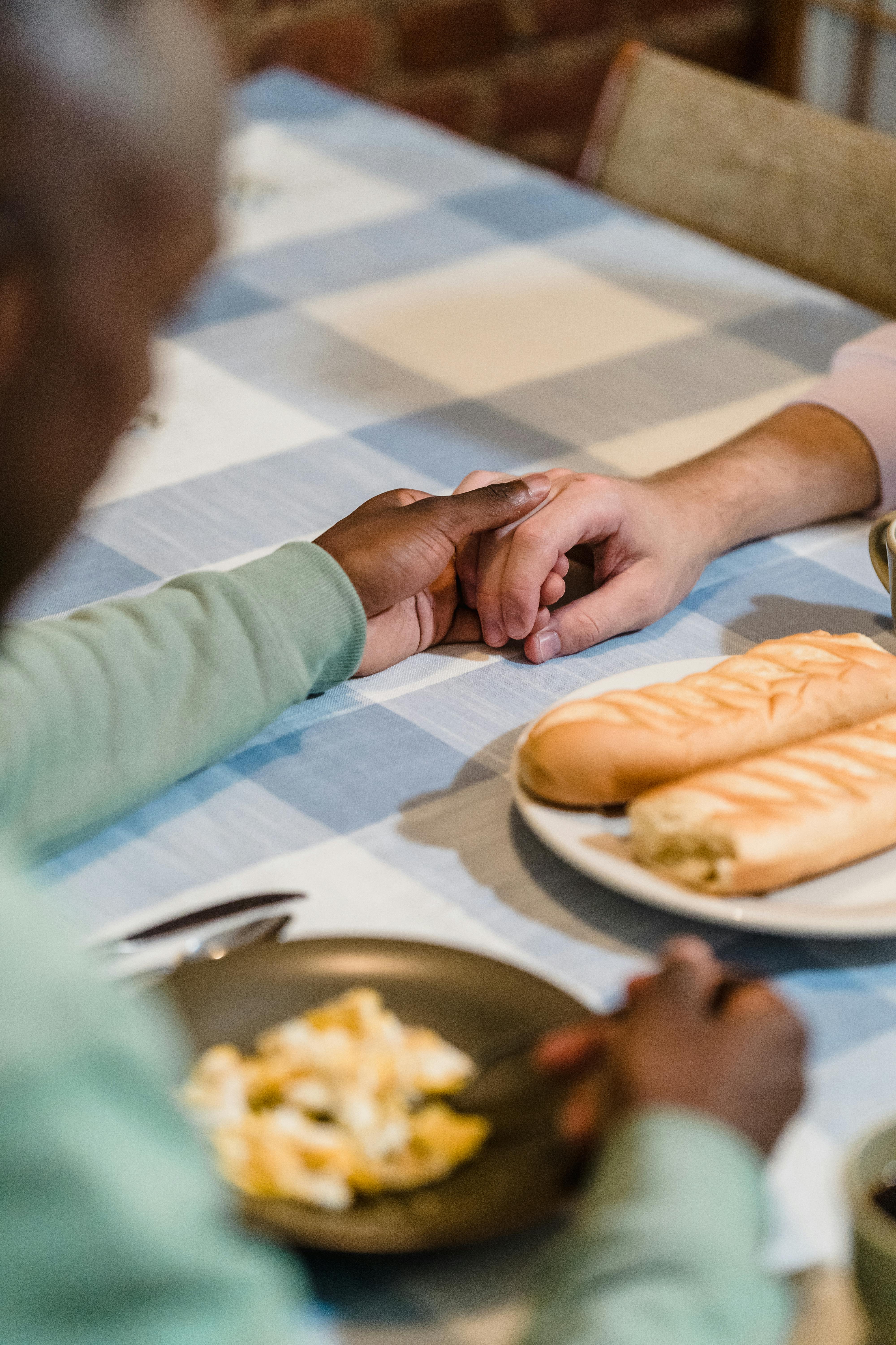 Men Holding Hands on Table · Free Stock Photo