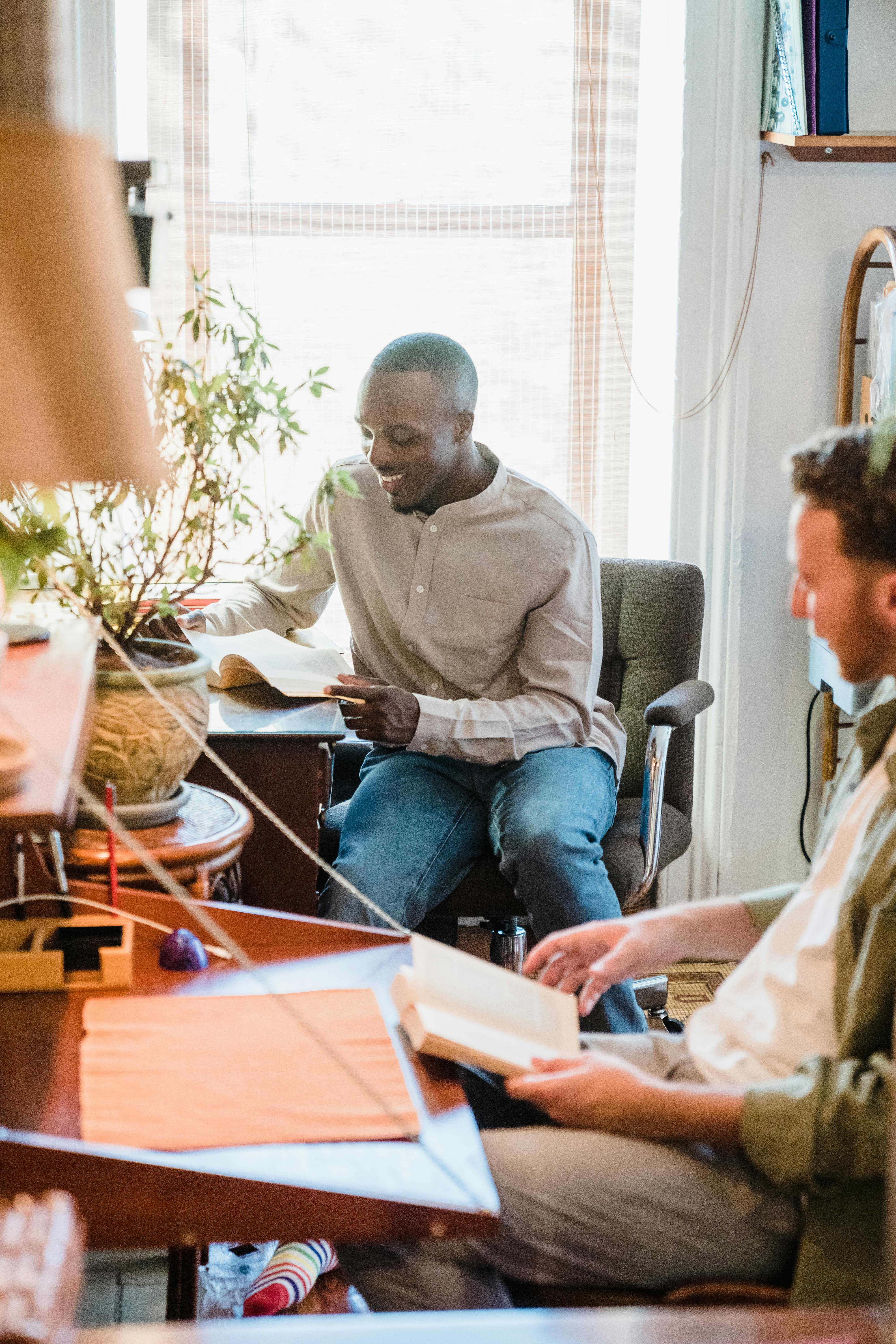 Smiling Men Reading Books · Free Stock Photo