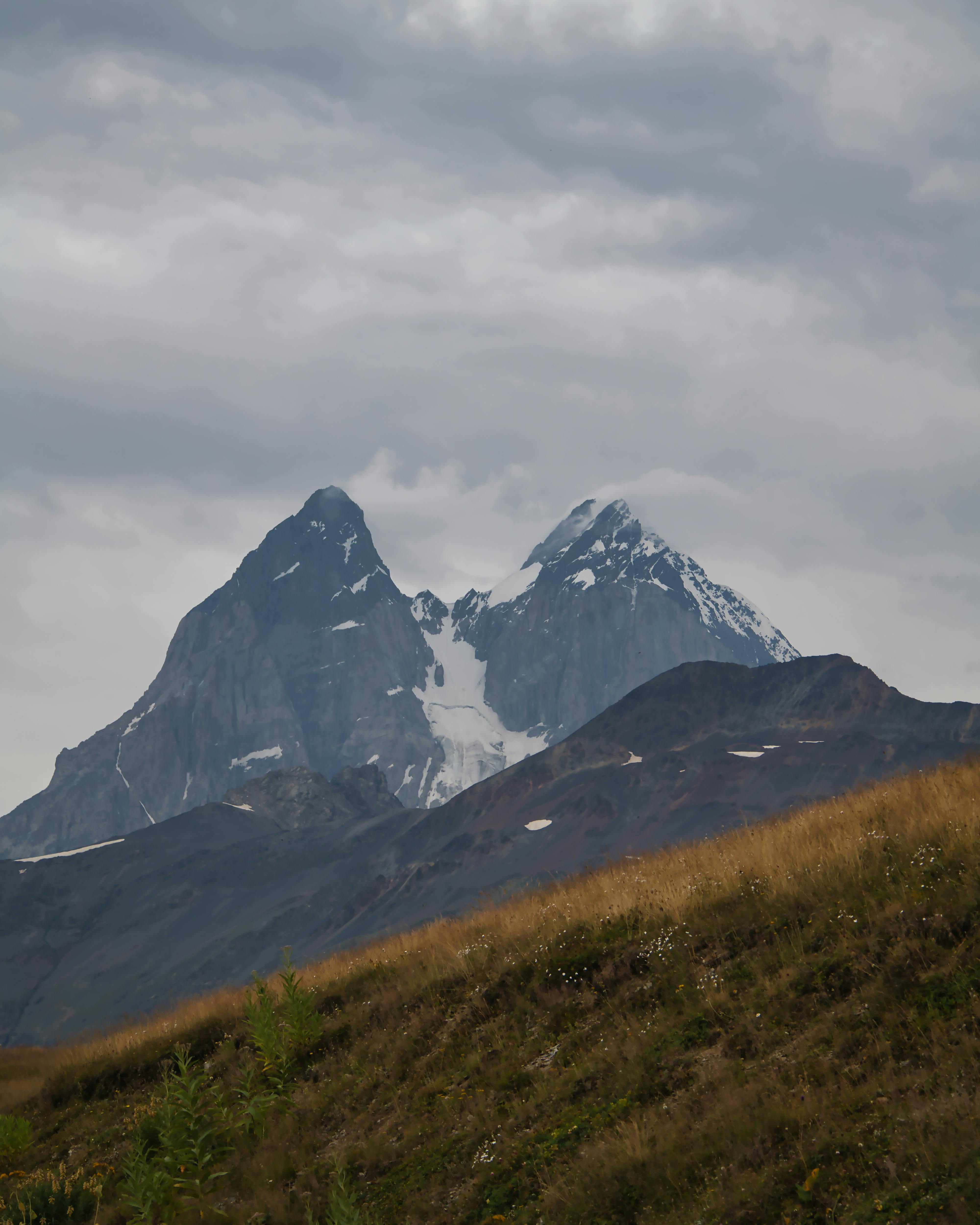 Gray Rocky Mountain under Gray Sky · Free Stock Photo