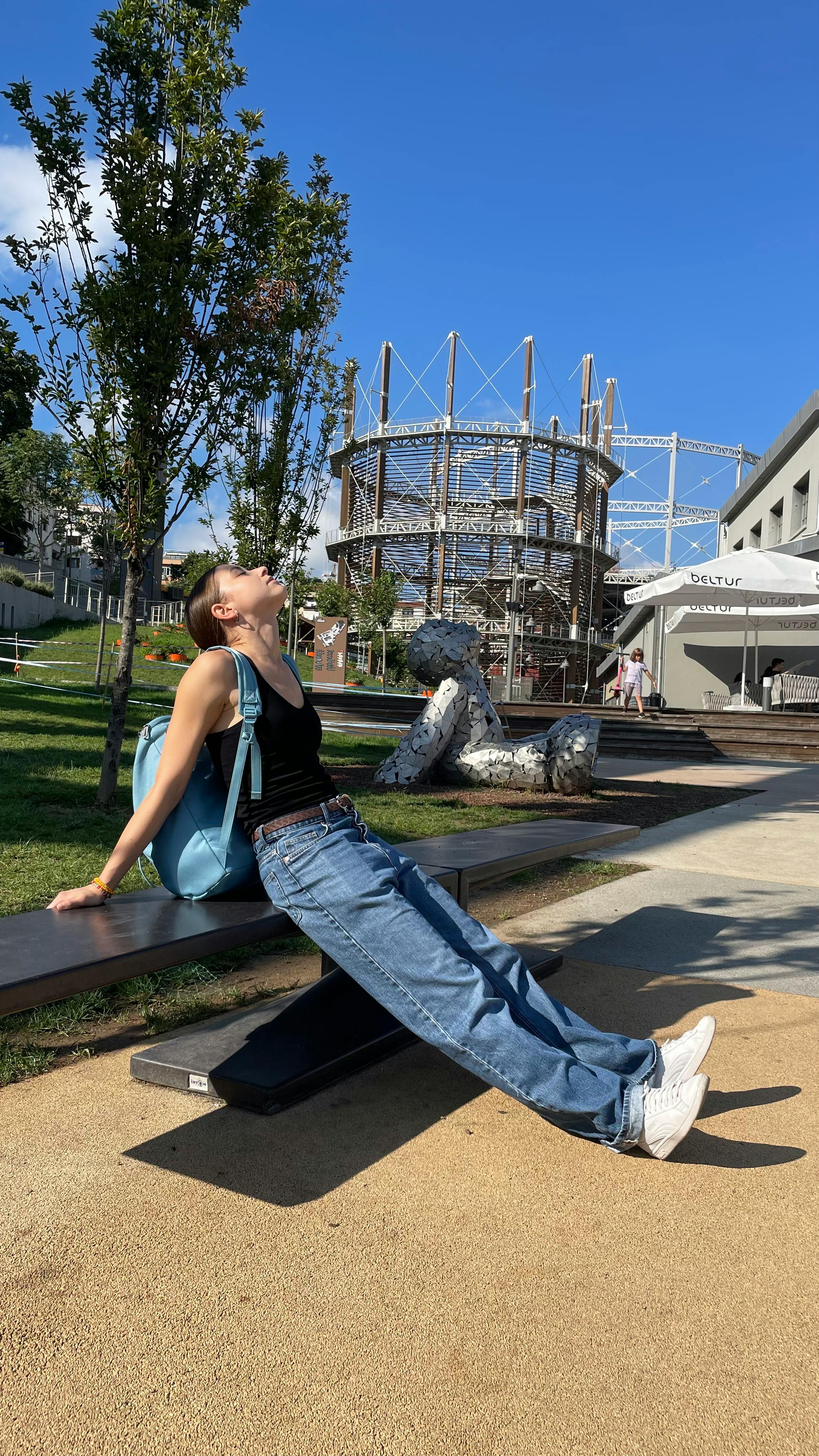 A Woman in Denim Jeans Sitting on the Bench · Free Stock Photo