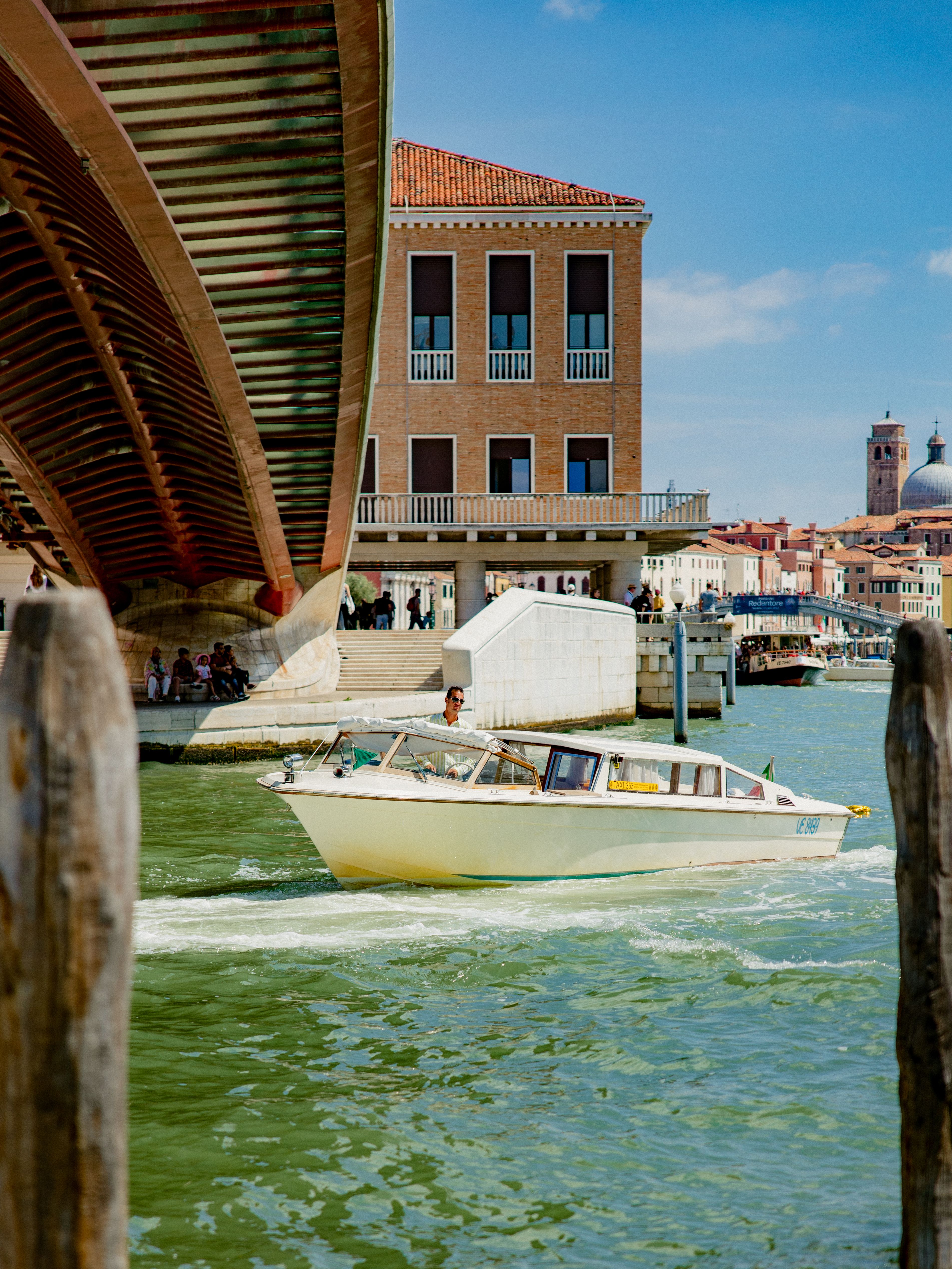Man in a Speedboat Under a Bridge · Free Stock Photo