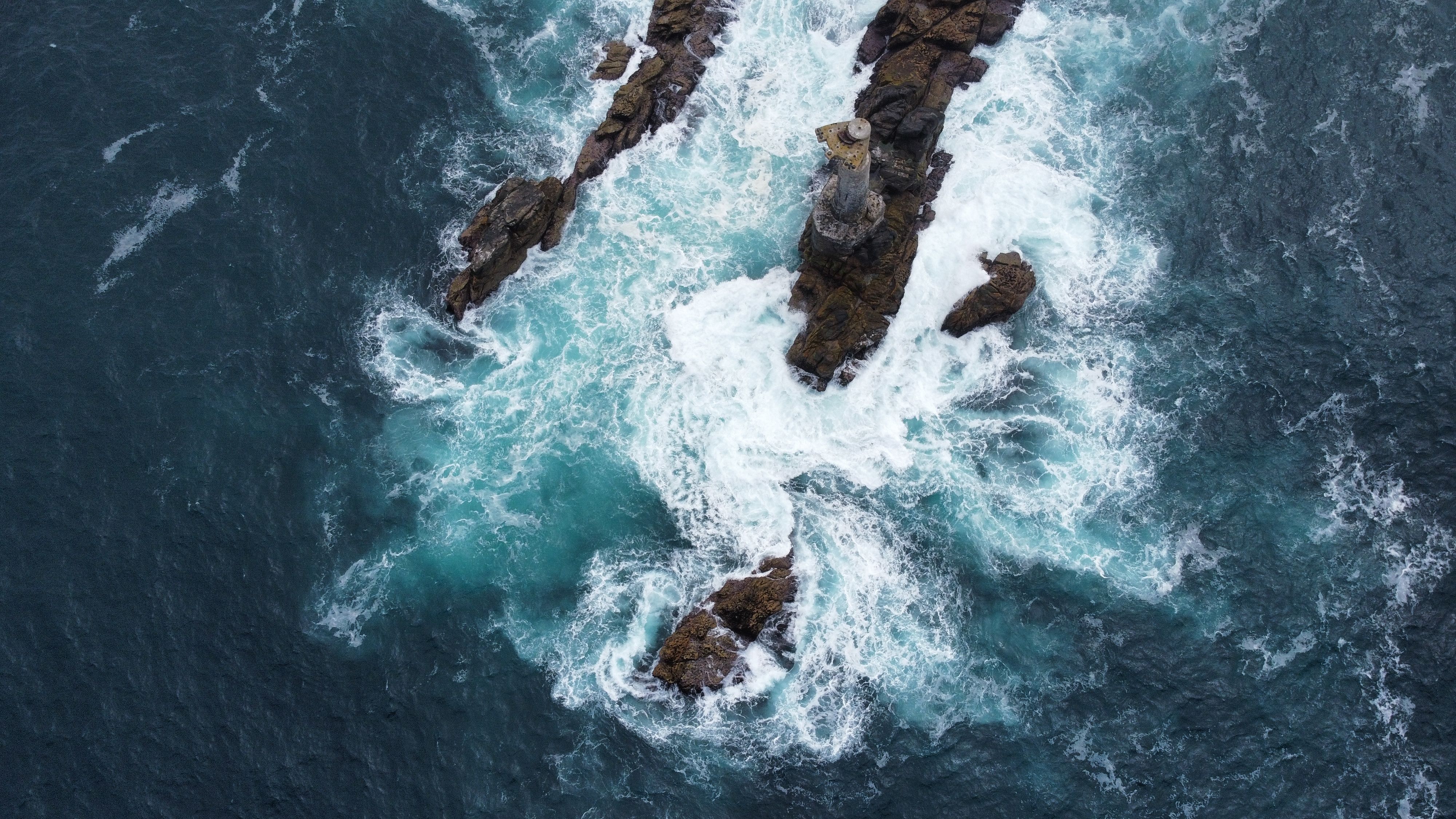 An Aerial Photography of Ocean Waves Crashing on Rock Formations · Free ...