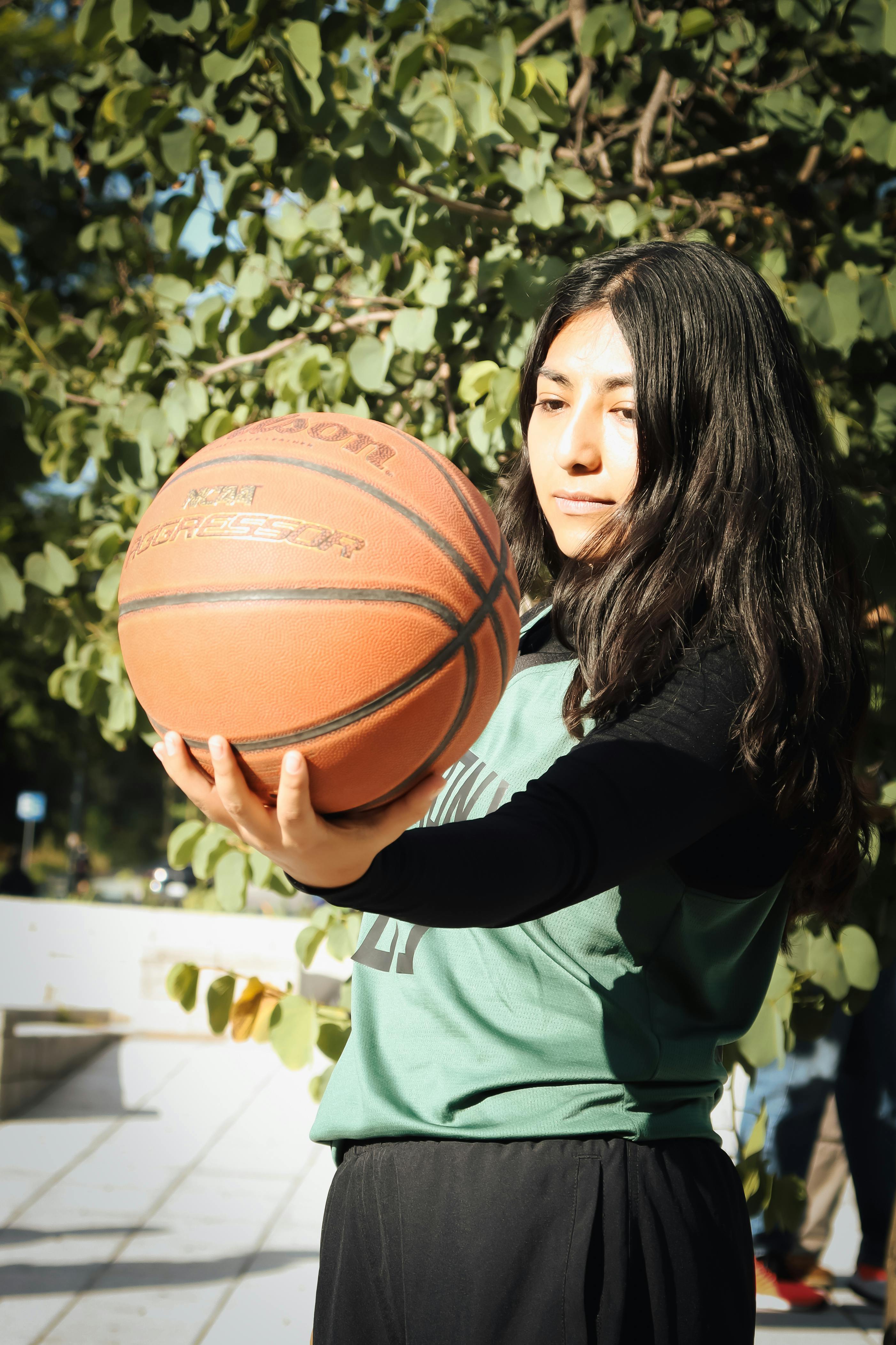 A Teenage Girl Holding a Basketball · Free Stock Photo