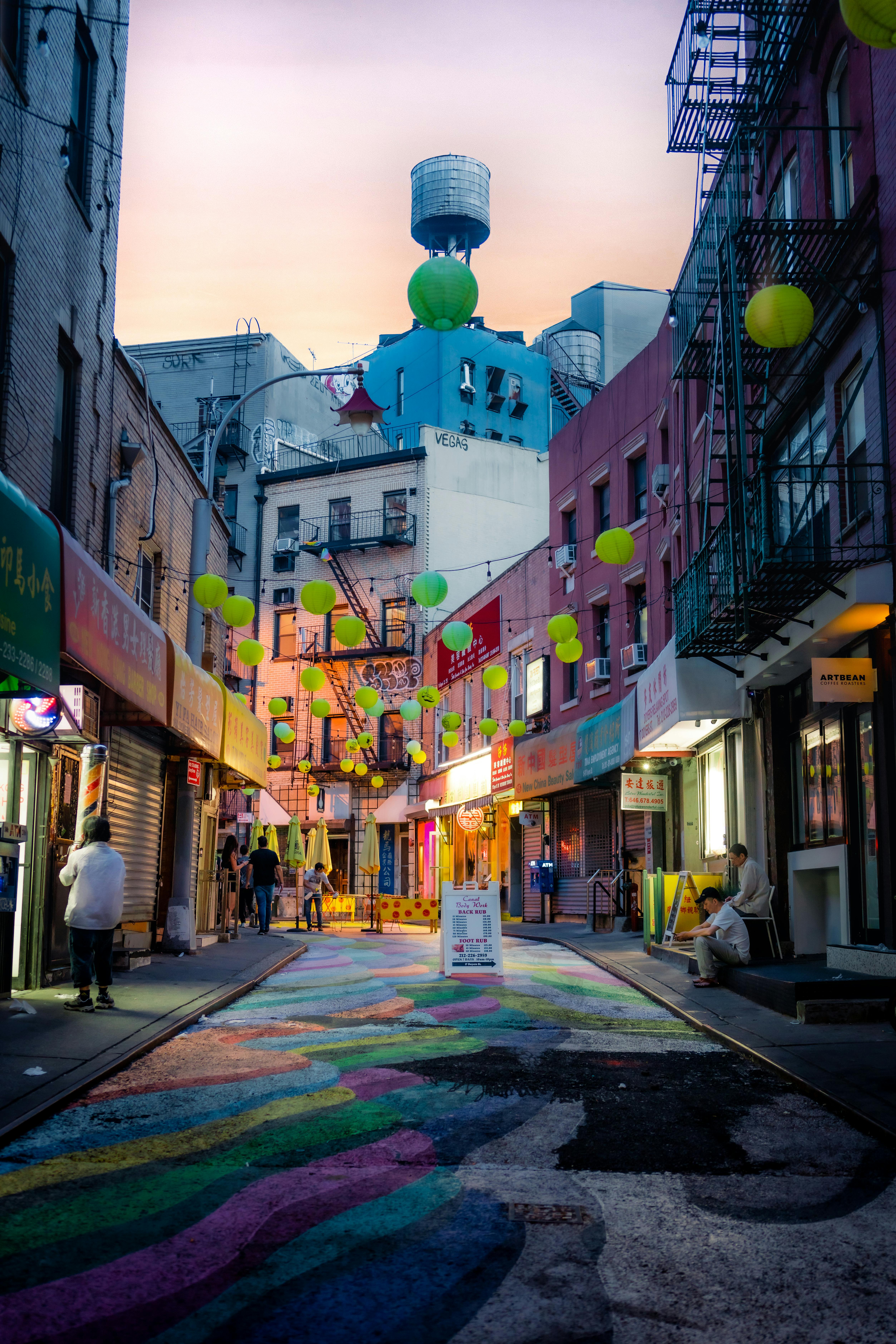 PeOple Walking Between Buildings · Free Stock Photo