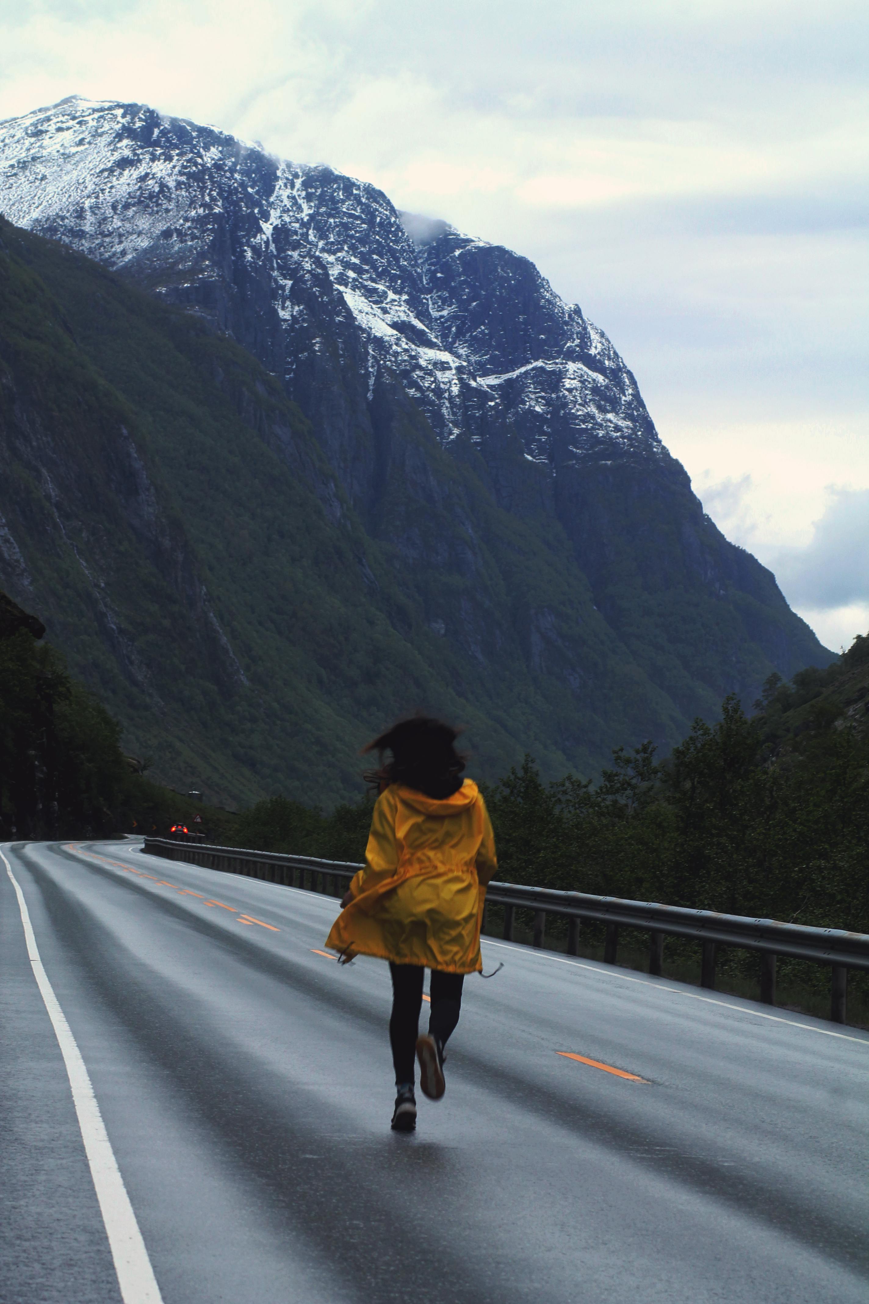 Woman in Yellow Jacket Running on the Road · Free Stock Photo