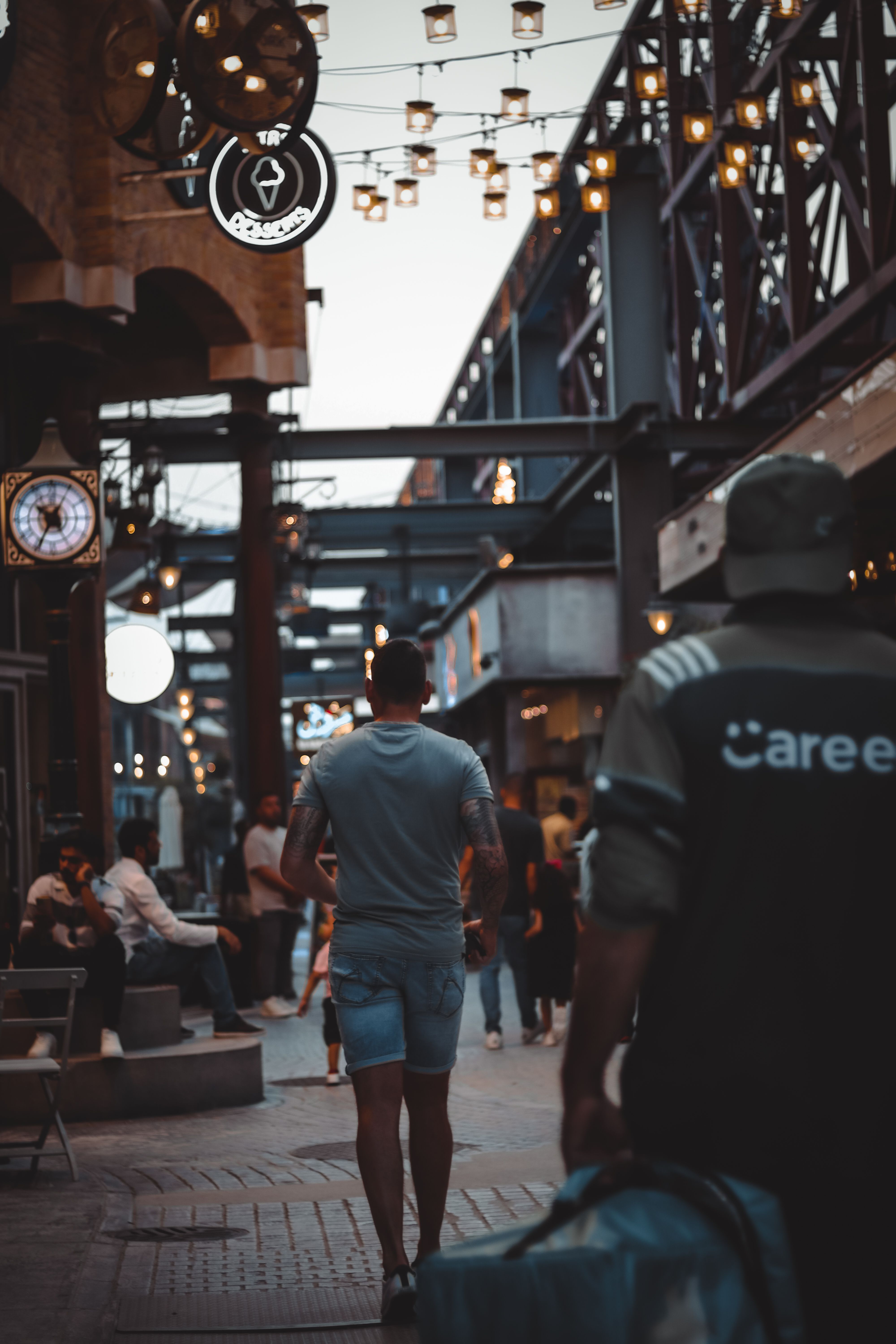 People Walking on Street Along Restaurant in City · Free Stock Photo